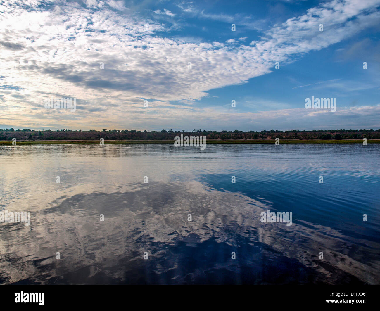 Chobe river landscape with sky reflected in the water Stock Photo - Alamy