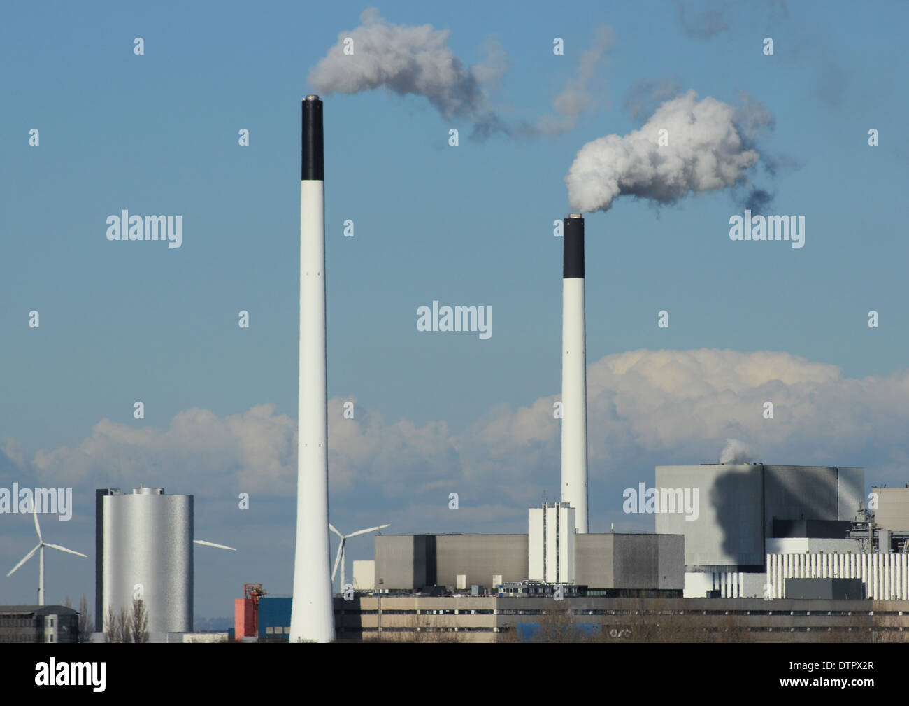 Factory chimneys with clouds and small windmills Stock Photo - Alamy