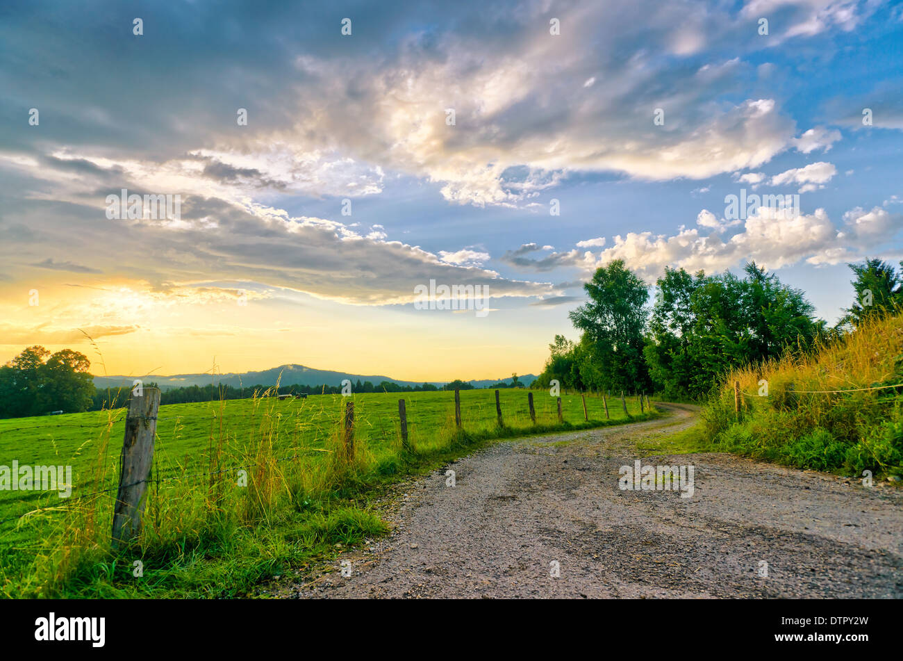 Summer Sunset above hilly Farmland, Country Road, Bavarian Alps Stock ...