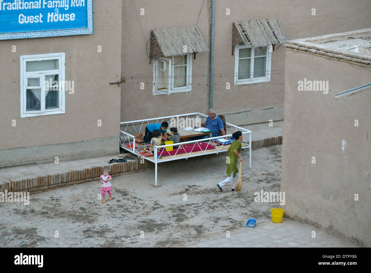 Local family spending an evening on a tapchan outside of their home ...