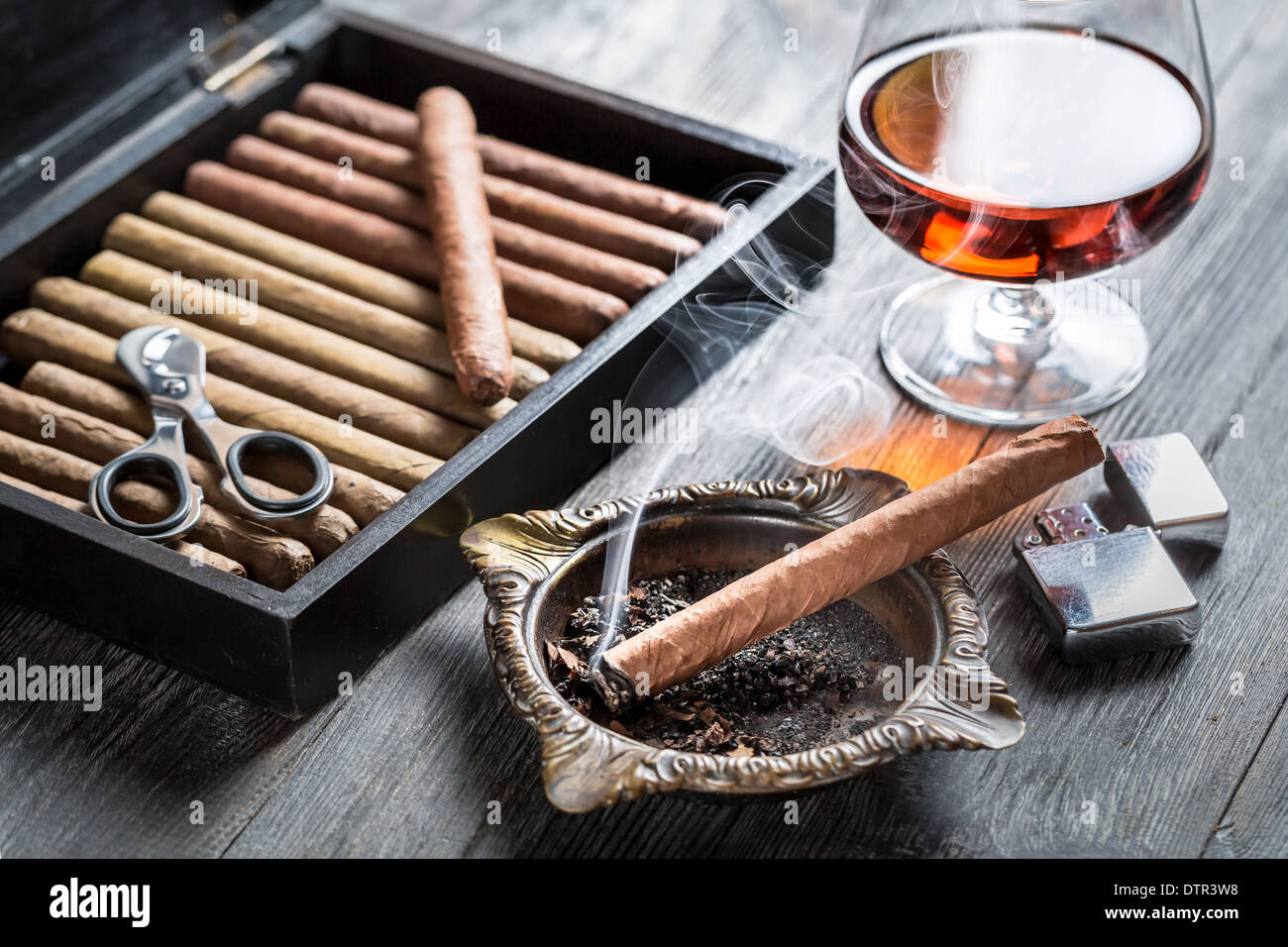 Smell of brandy and smoking a cigar Stock Photo - Alamy