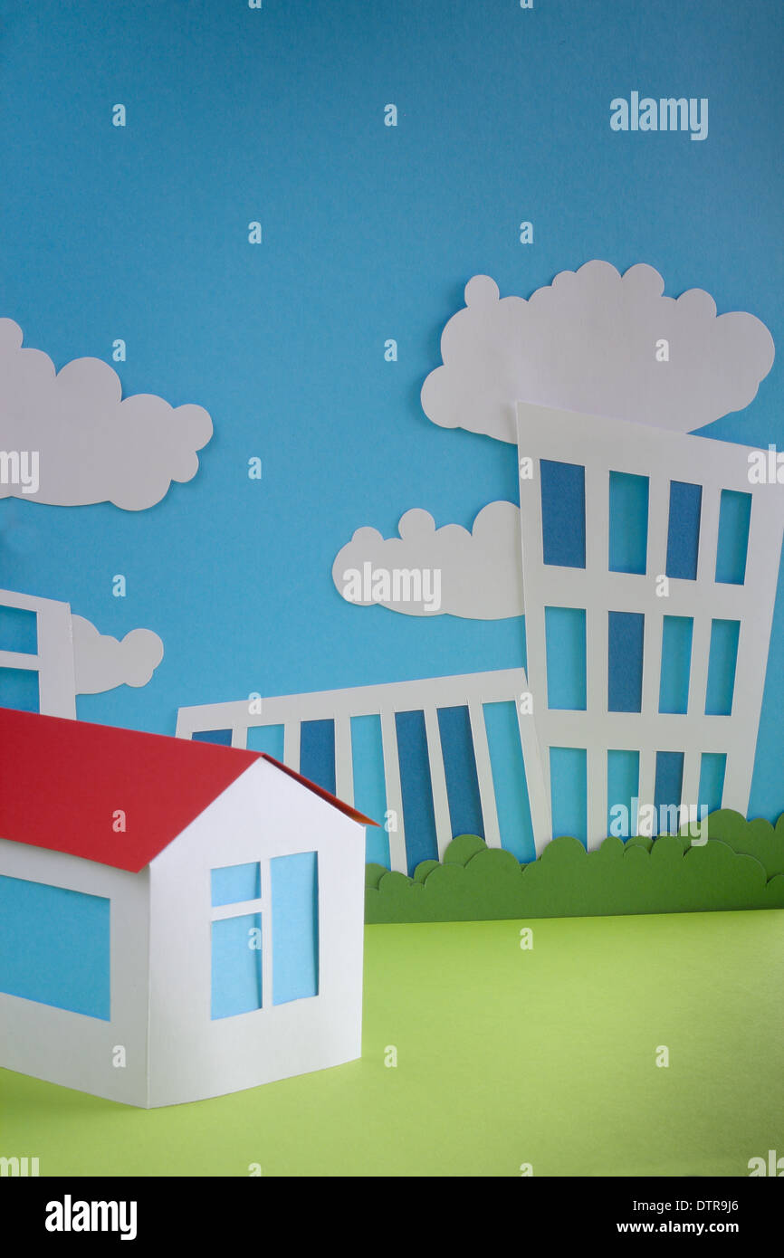 Paper cottage over city background real estate concept Stock Photo - Alamy
