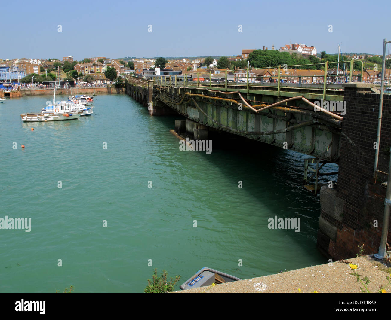 A landscape view showing the old boats and a bridge at Folkestone ...