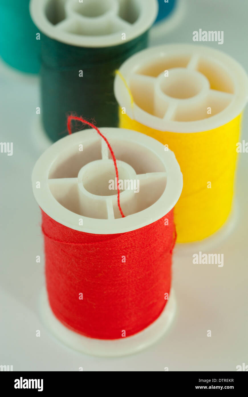 multiple coils with color threads on white background Stock Photo - Alamy