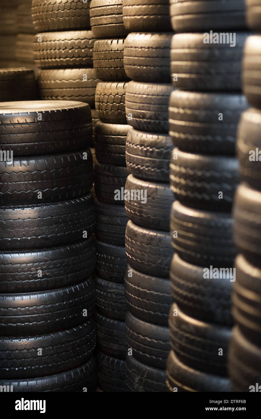 Stack of car tyres in a distribution centre, artificial lighting Stock ...
