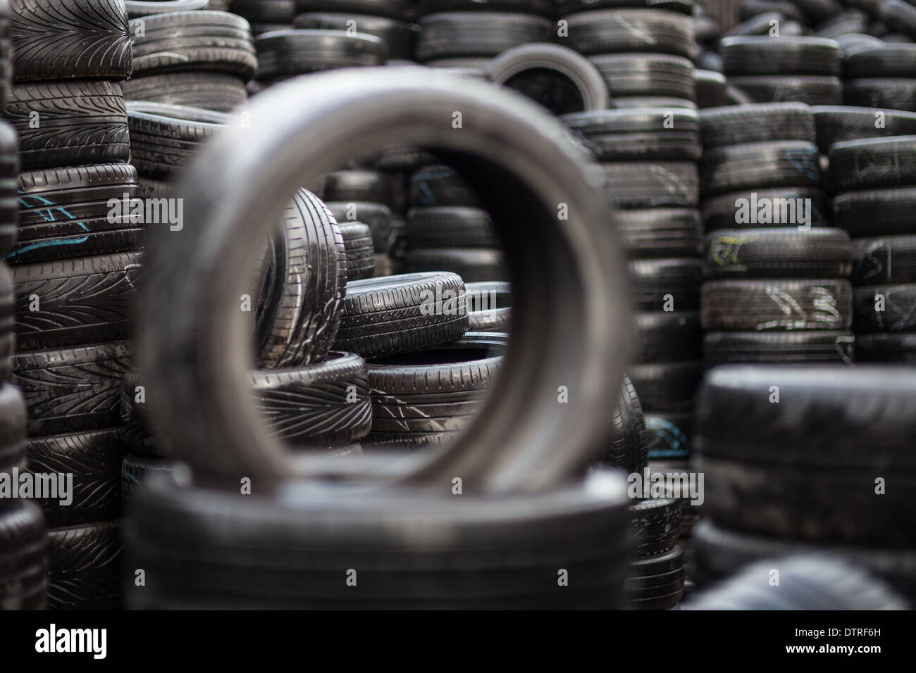 Stack of car tyres in a distribution centre Stock Photo - Alamy