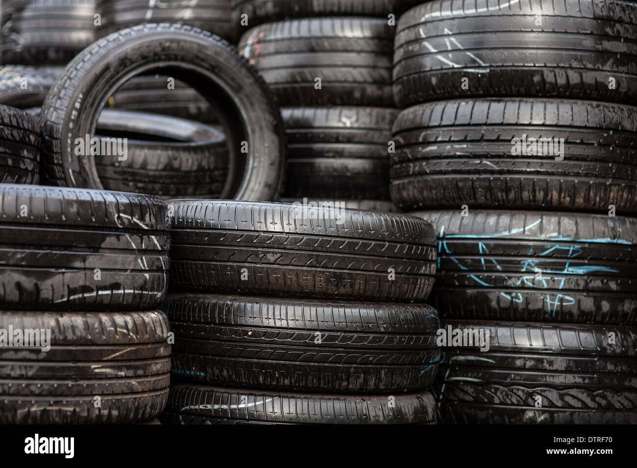 Stack of car tyres in a distribution centre Stock Photo - Alamy