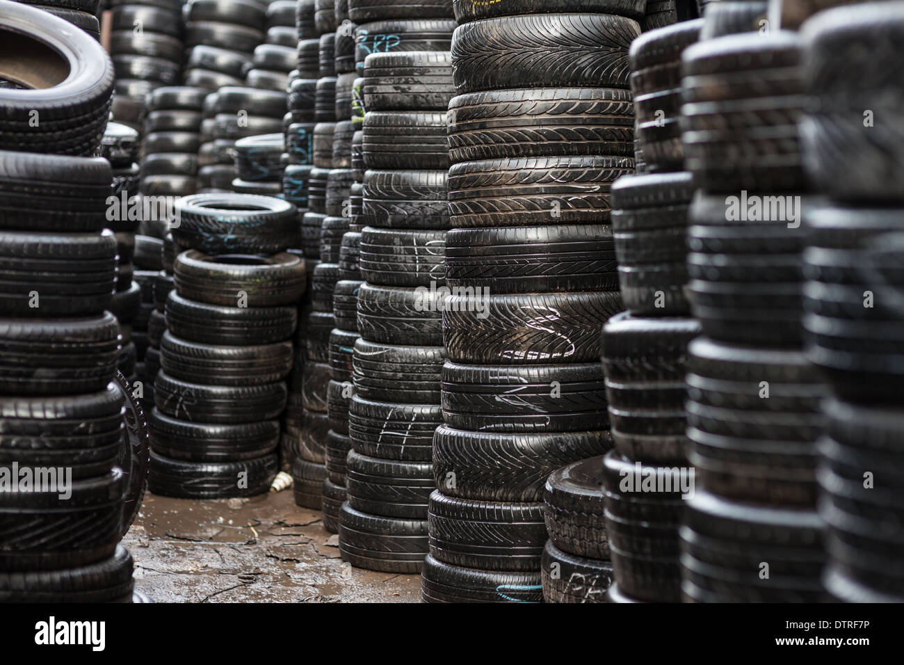 Stack of car tyres in a distribution centre Stock Photo - Alamy