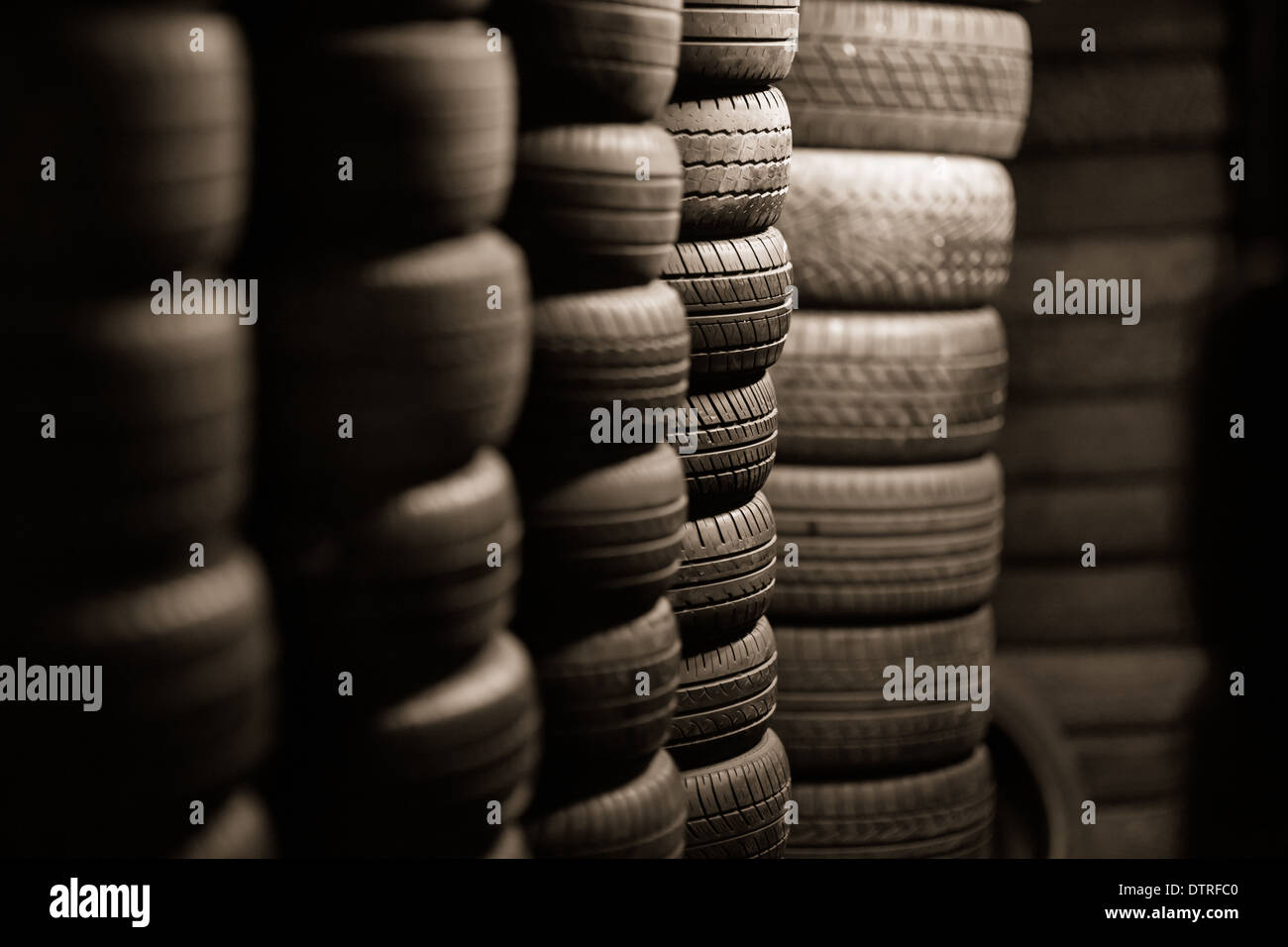 Stack of car tyres in a distribution centre Stock Photo - Alamy