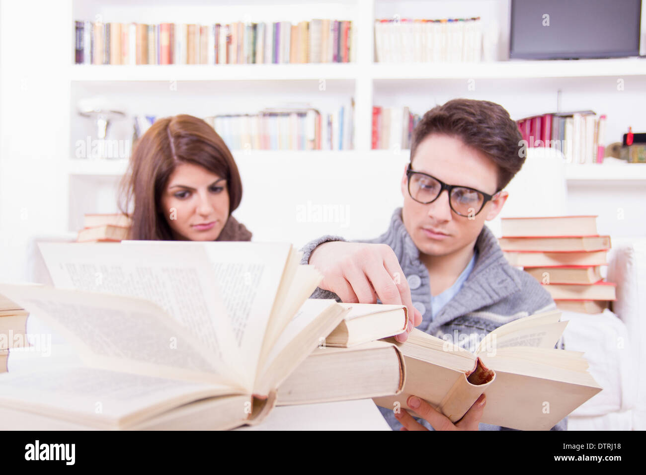 couple studying together at home with lot of books Stock Photo - Alamy