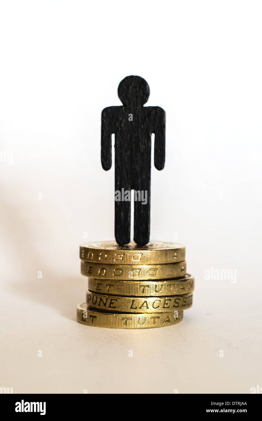 Diorama featuring small wooden figure atop a pile of coins Stock Photo ...