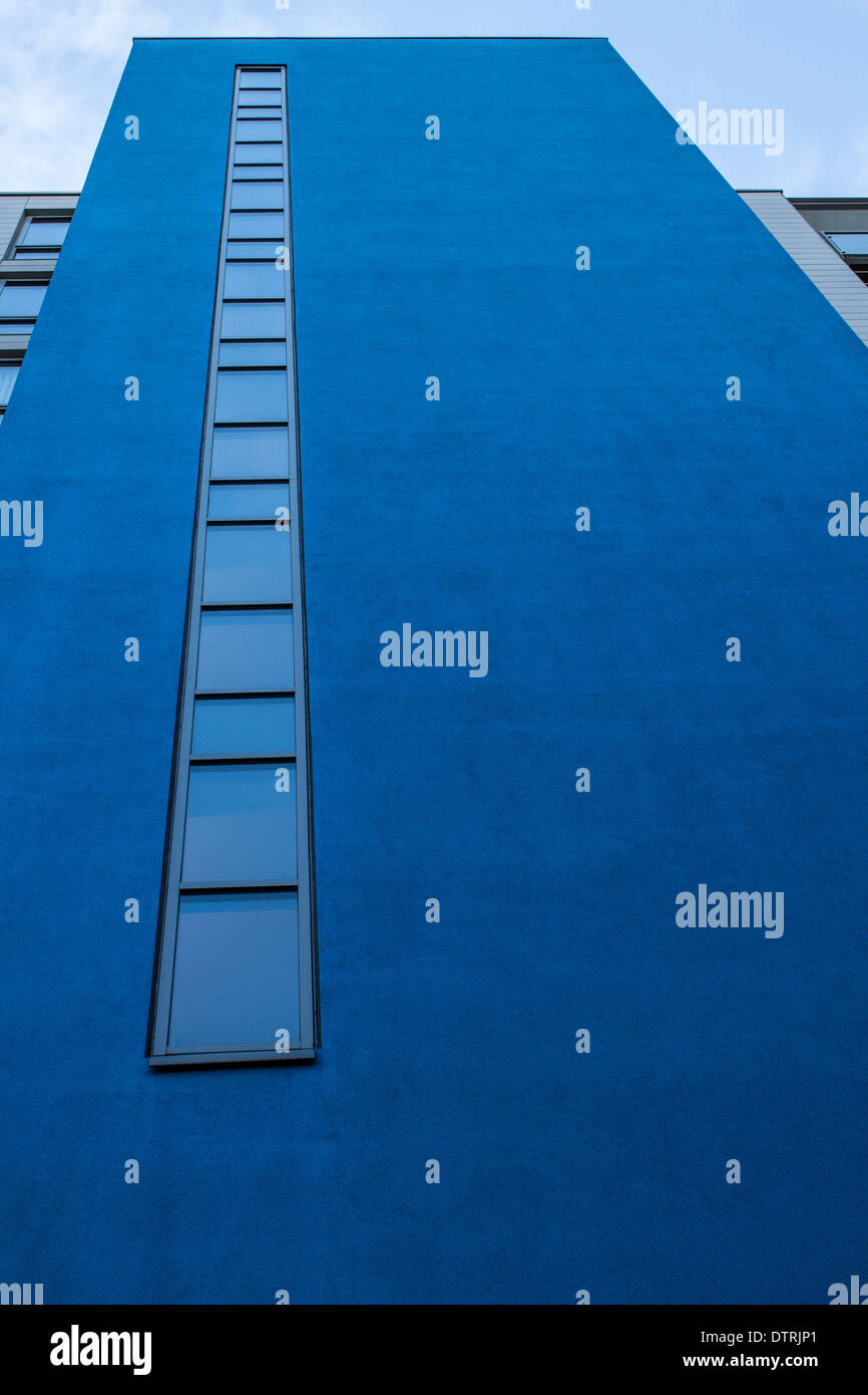 Long window in a tall blue wall Stock Photo - Alamy
