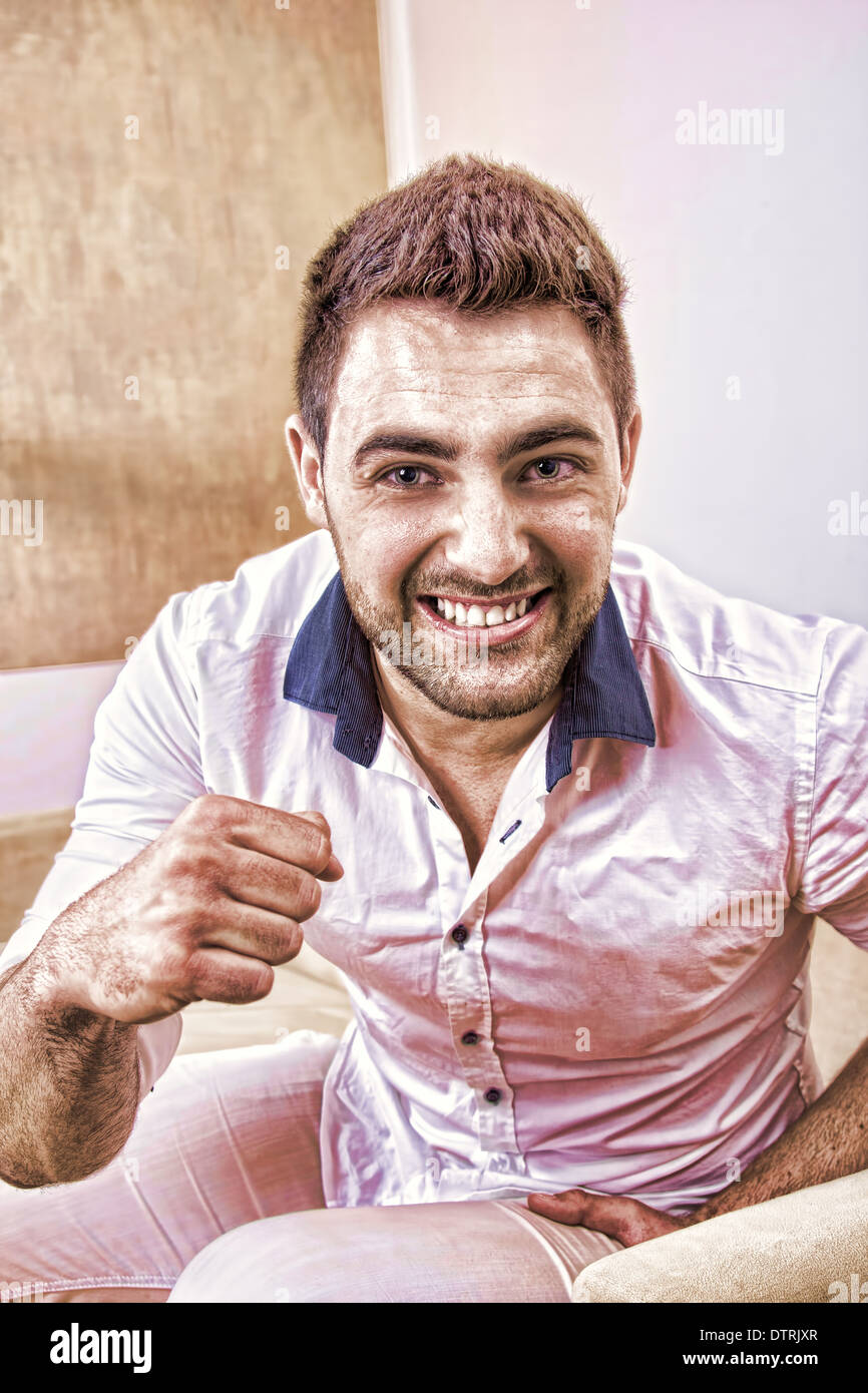 strong hadsome man laughing and showing his fist Stock Photo - Alamy