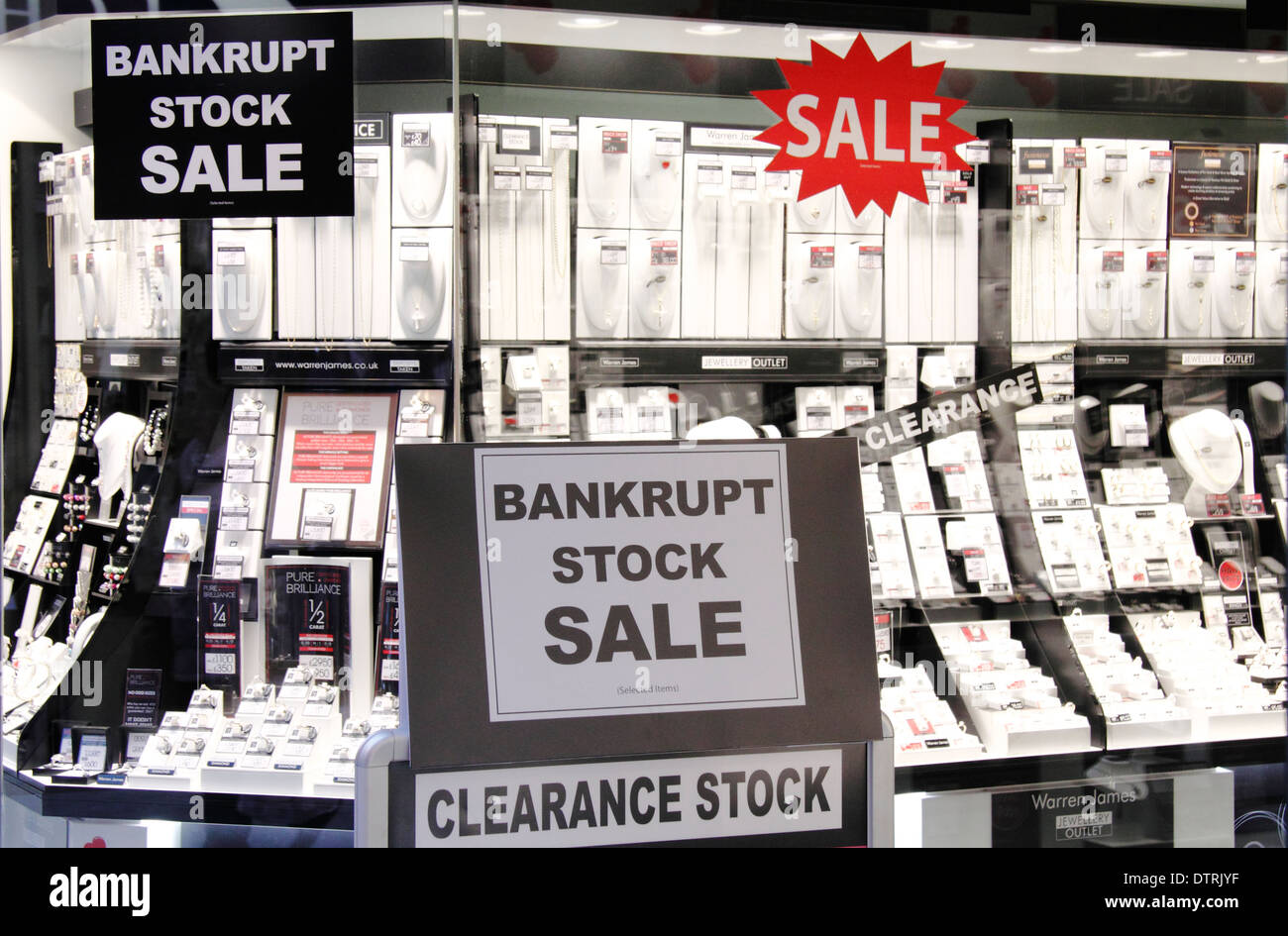 Bankrupt stock sale and clearance stock sale advertisement in window of ...