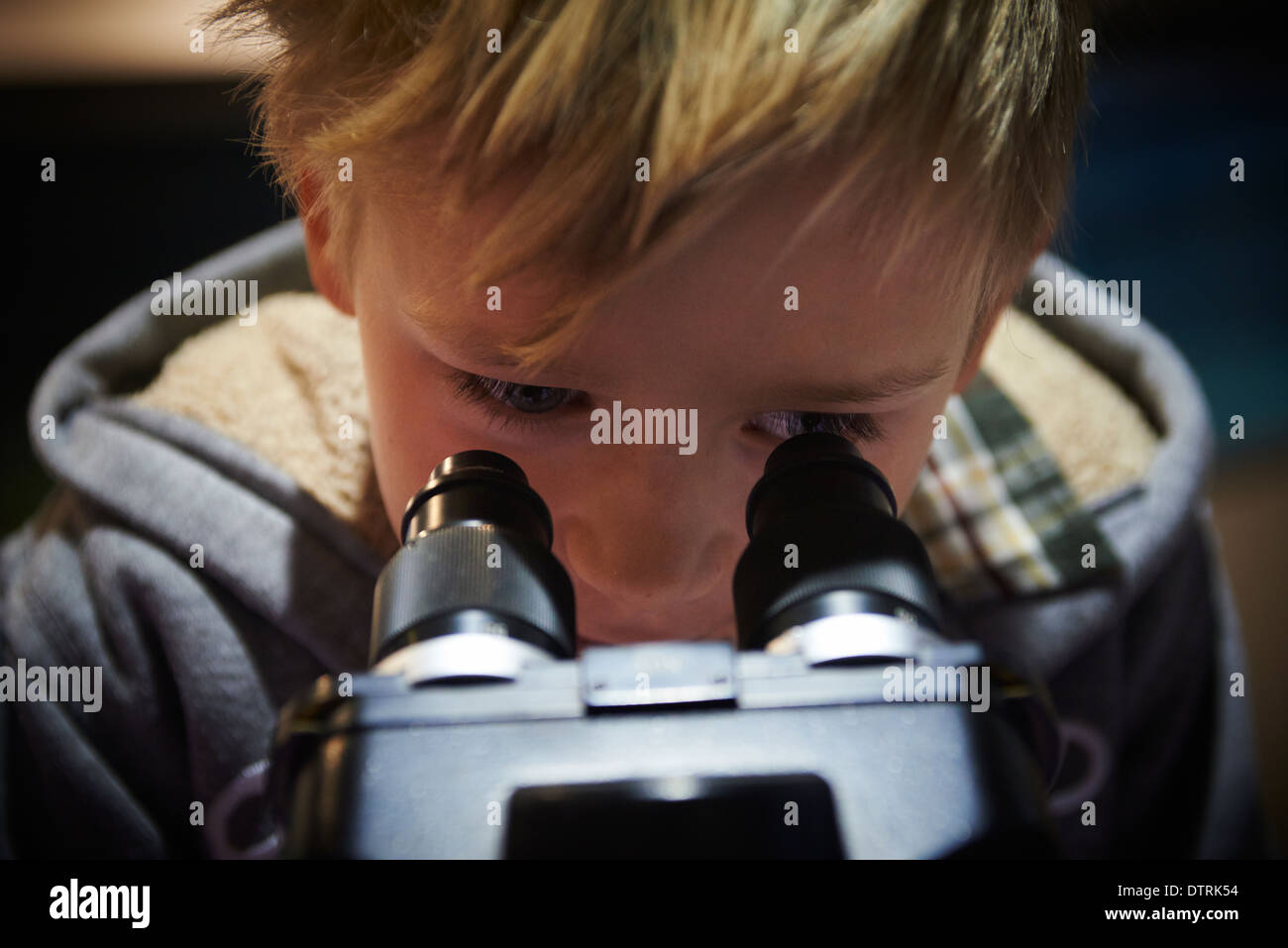 Portrait of Child Boy looking through microscope in school laboratory ...