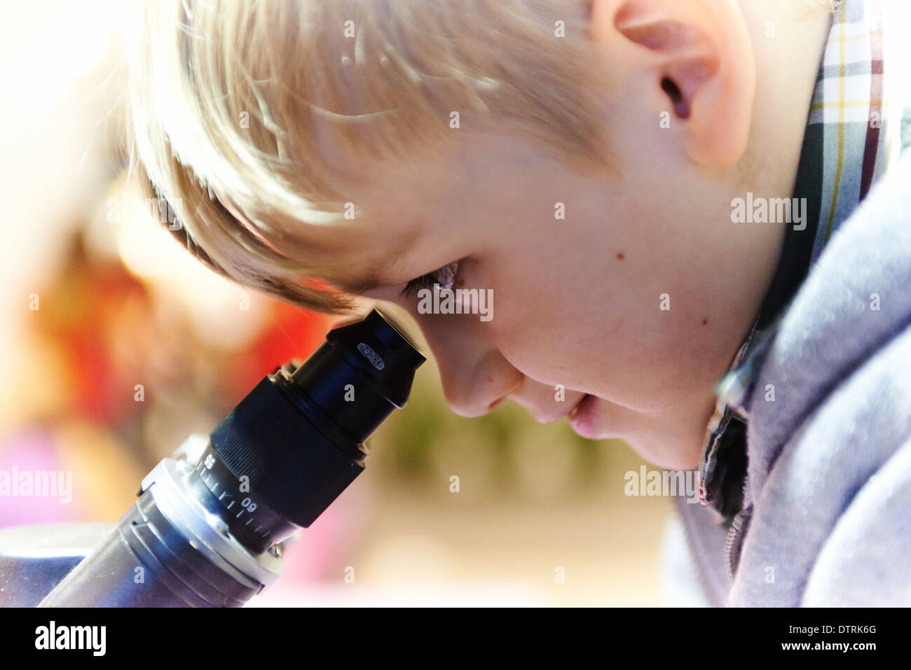 Portrait of Child Boy looking through microscope in school laboratory ...