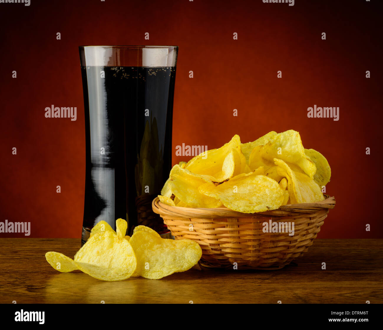 still life with potato chips and glass of cola drink Stock Photo - Alamy