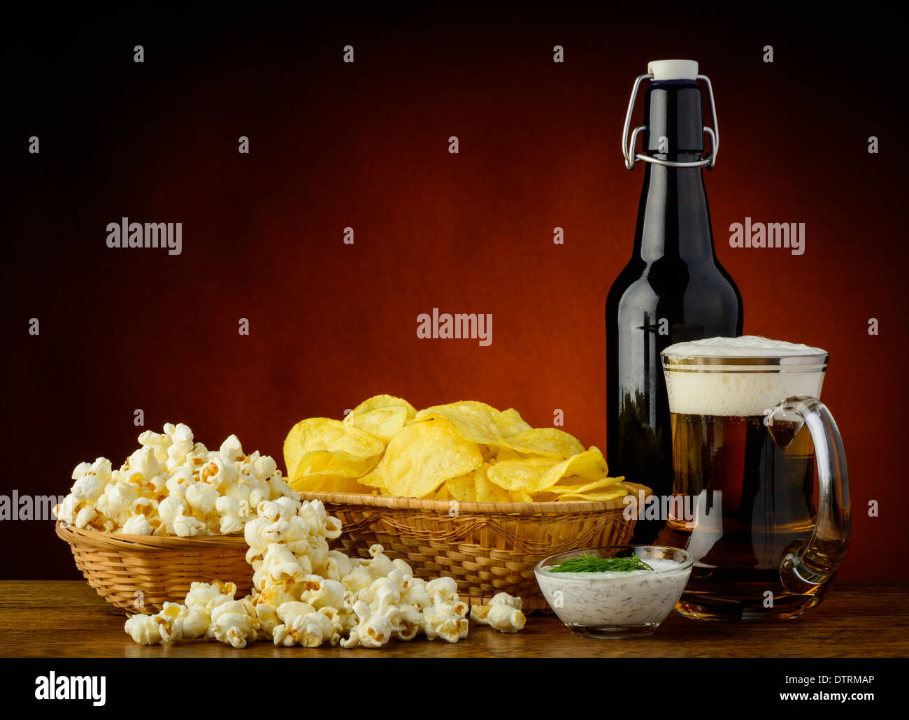 popcorn and potato chips snacks, dill sauce and beer Stock Photo - Alamy