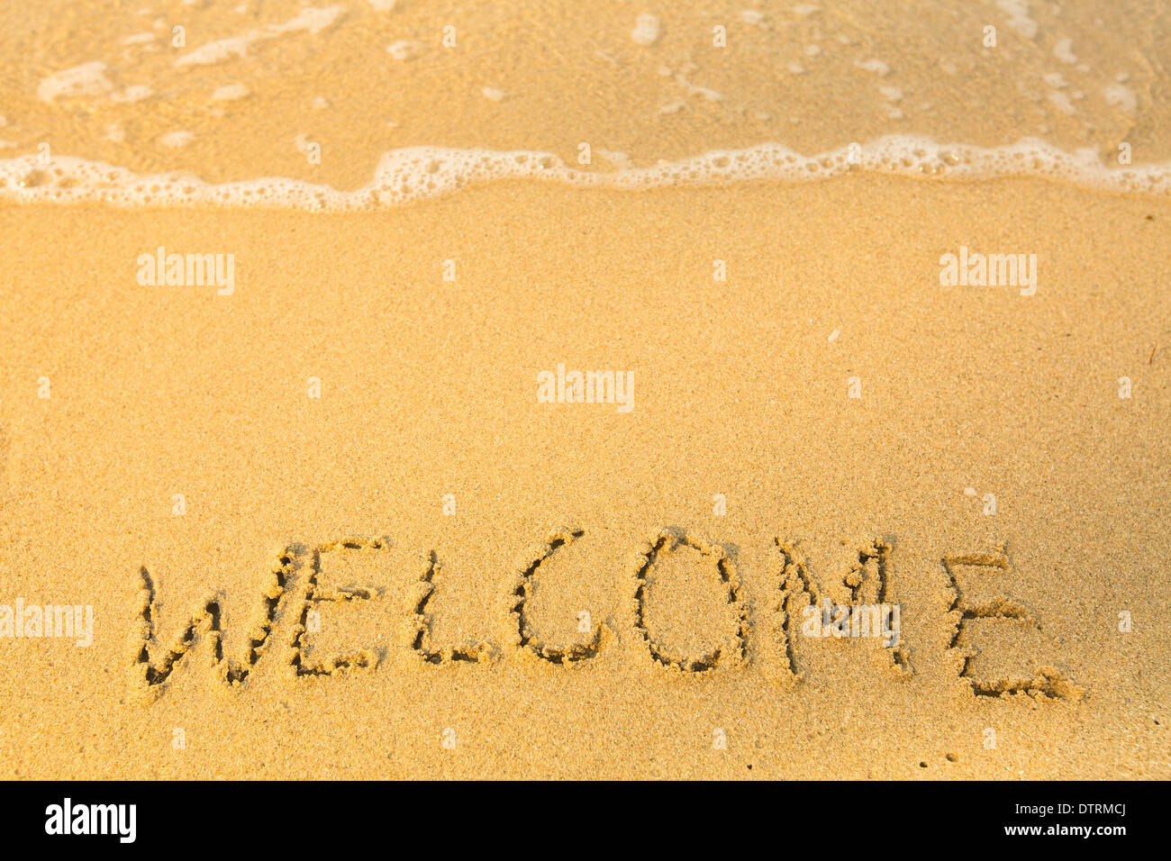 Welcome, written in sand on beach texture, soft wave of the sea Stock ...