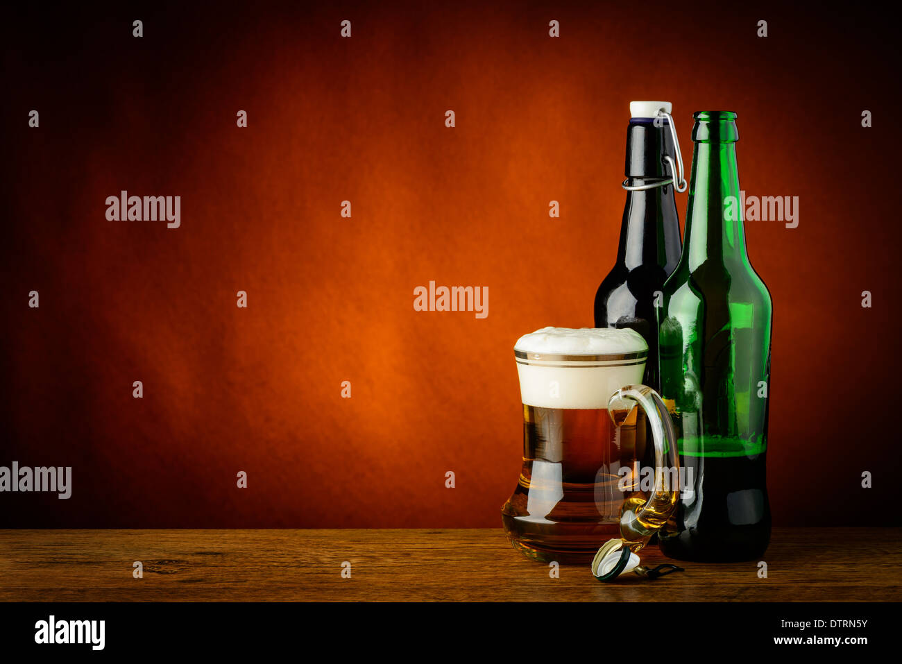 still life with mug and bottles of beer and text copy space Stock Photo ...