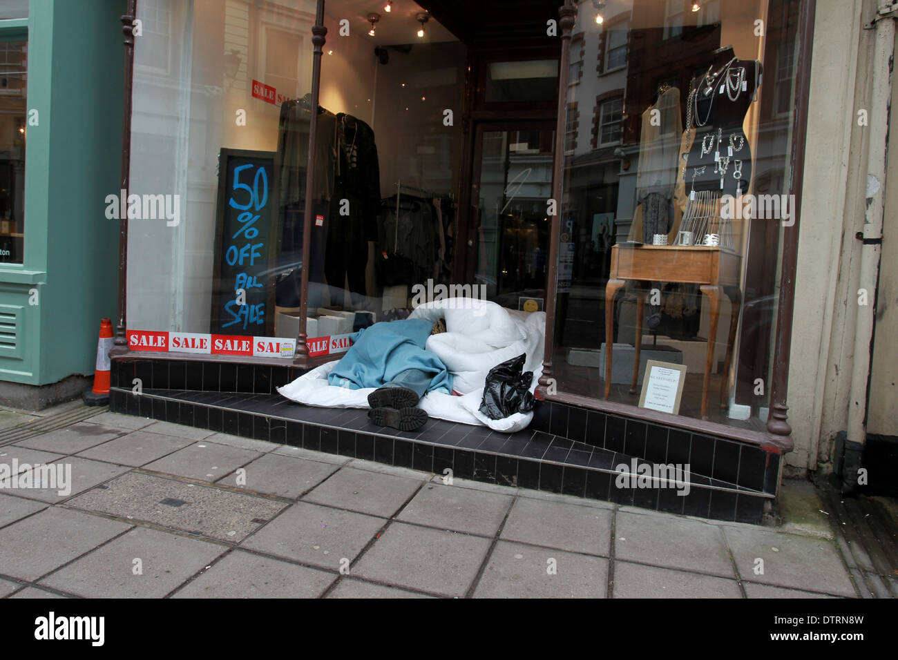 A homeless person pictured sleeping in a clothes shop doorway in the ...