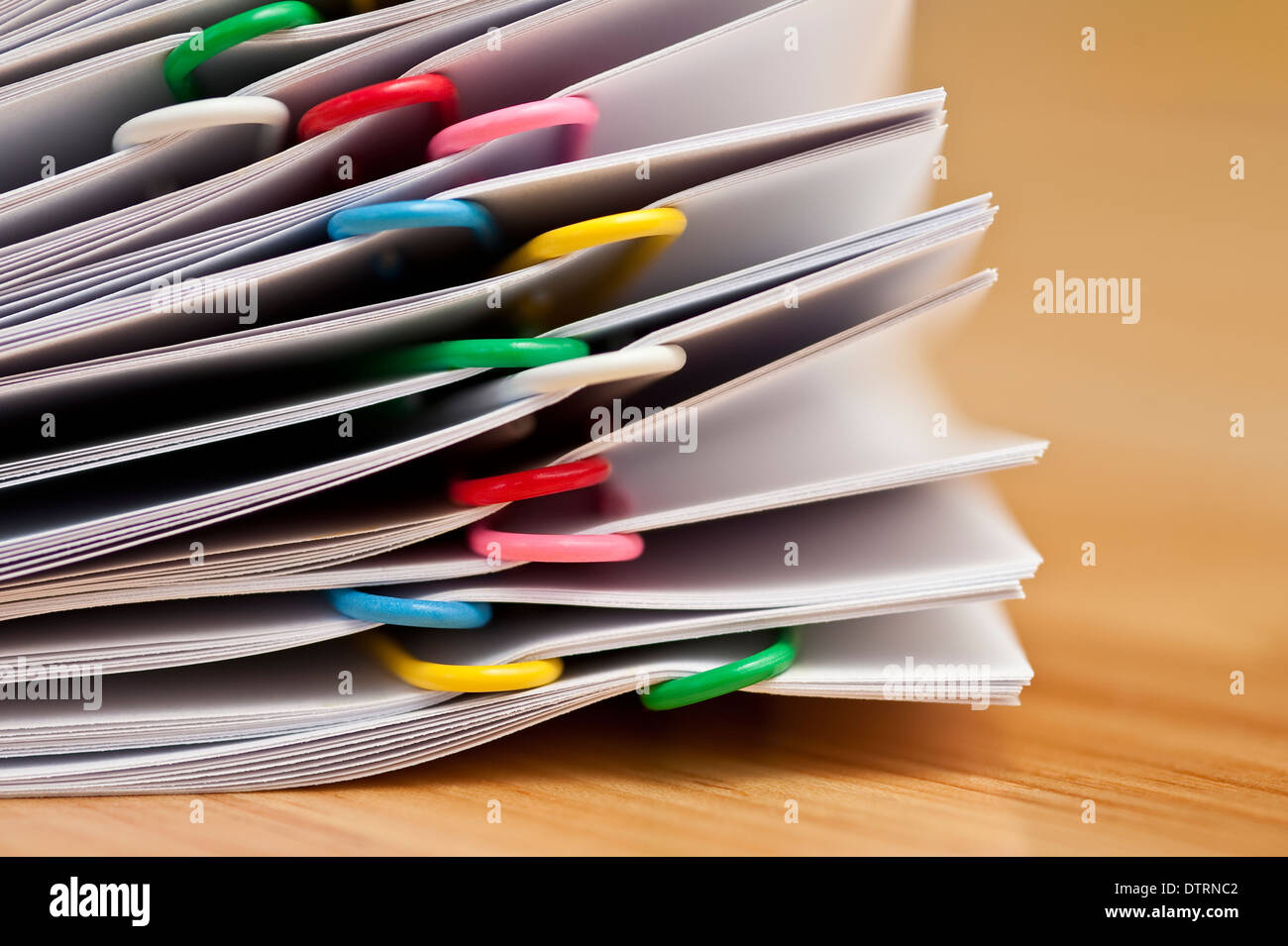 Documents stacked with multicolored paper clips close-ups Stock Photo ...