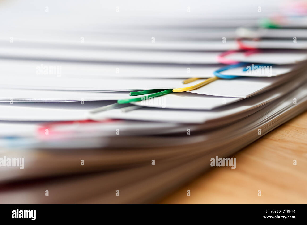 Documents stacked with multicolored paper clips close-ups Stock Photo ...
