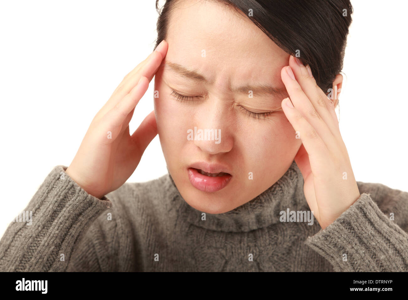 Young asian woman with headache on white background Stock Photo - Alamy