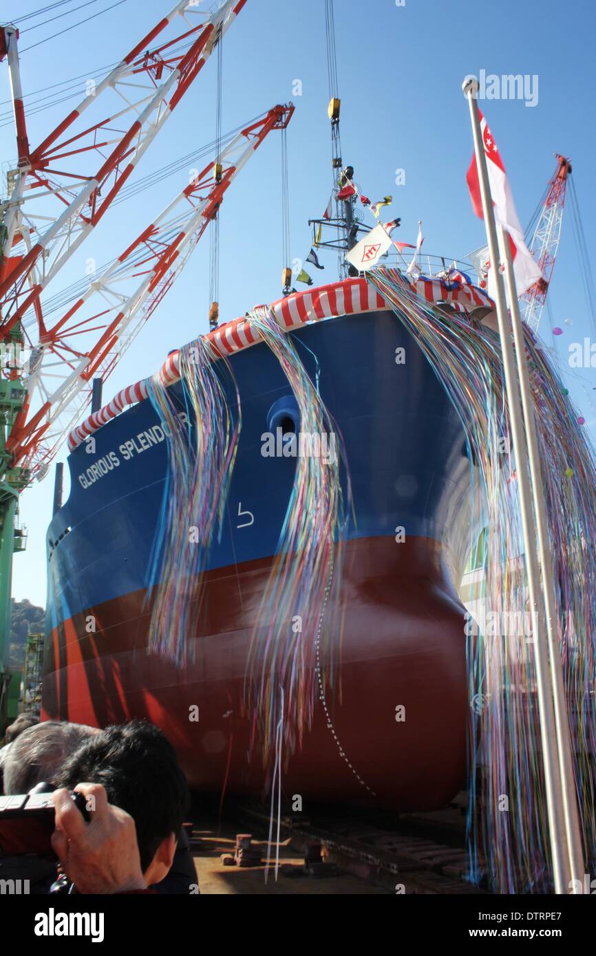 Ehime, Japan. 22nd Feb, 2014. As the ship slides down the slipway ...