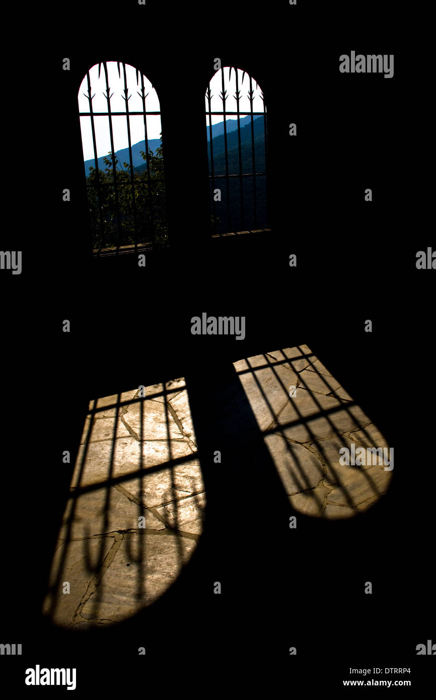 Two windows let the sunlight pass and create a couple of grid ...