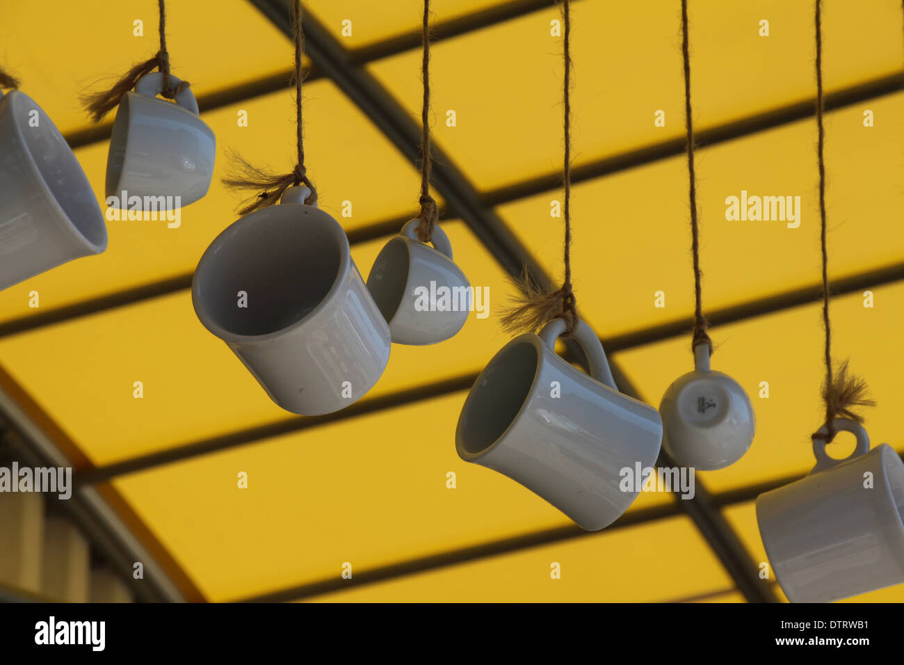 cups and mugs hang in a cafe display Stock Photo - Alamy