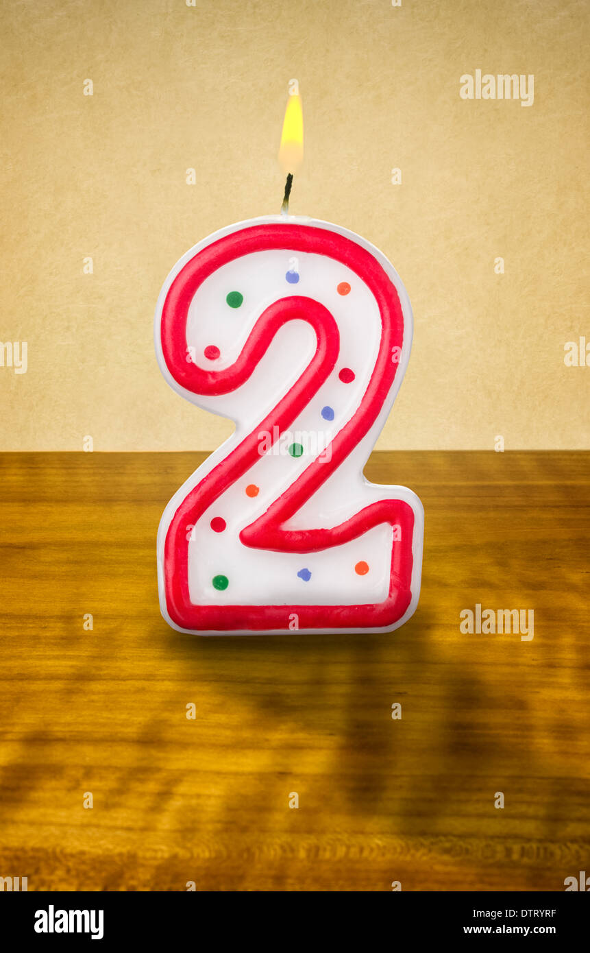 Burning birthday candle number 2 Stock Photo - Alamy