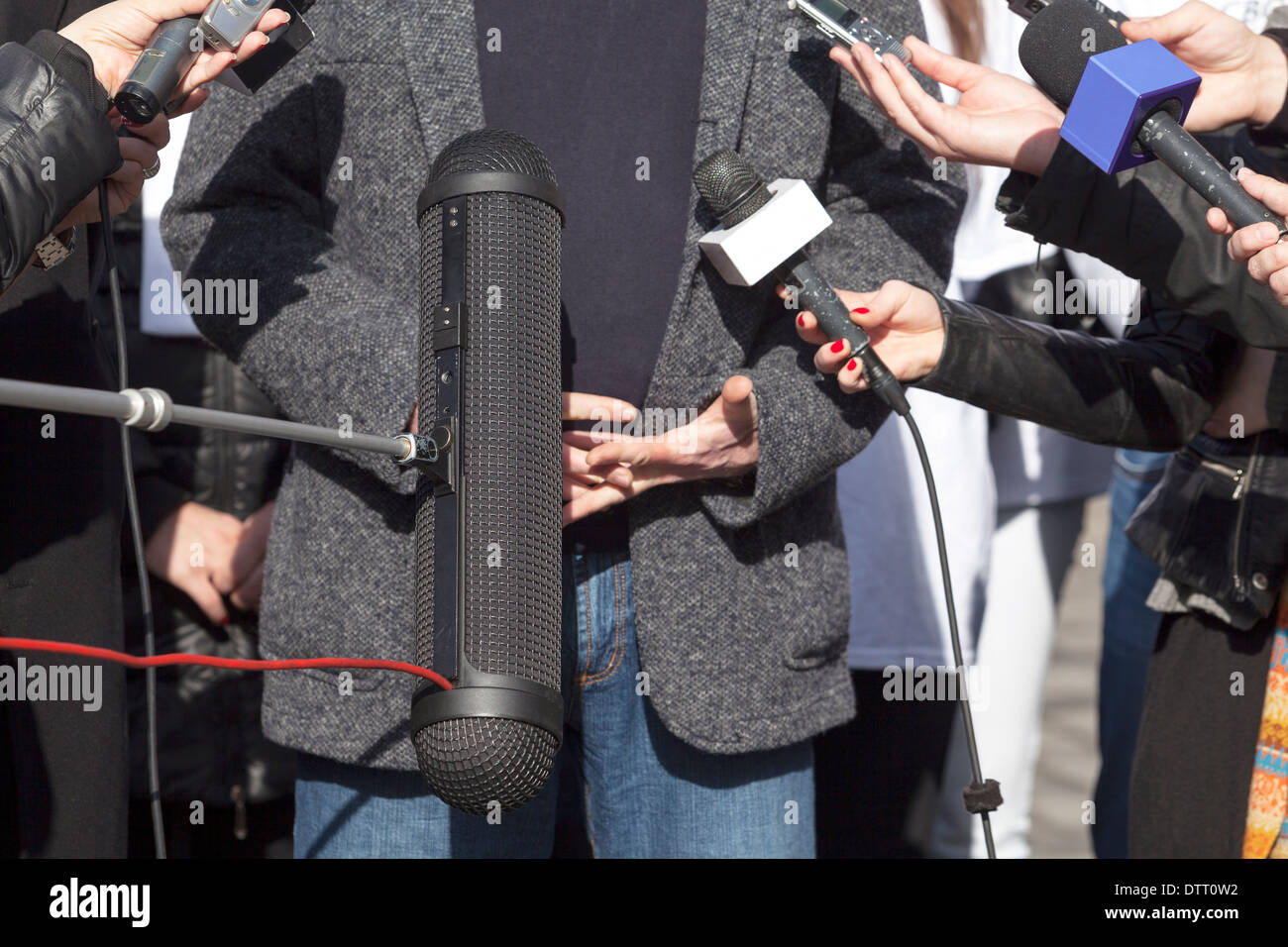 A journalist is making a interview with a microphone Stock Photo - Alamy