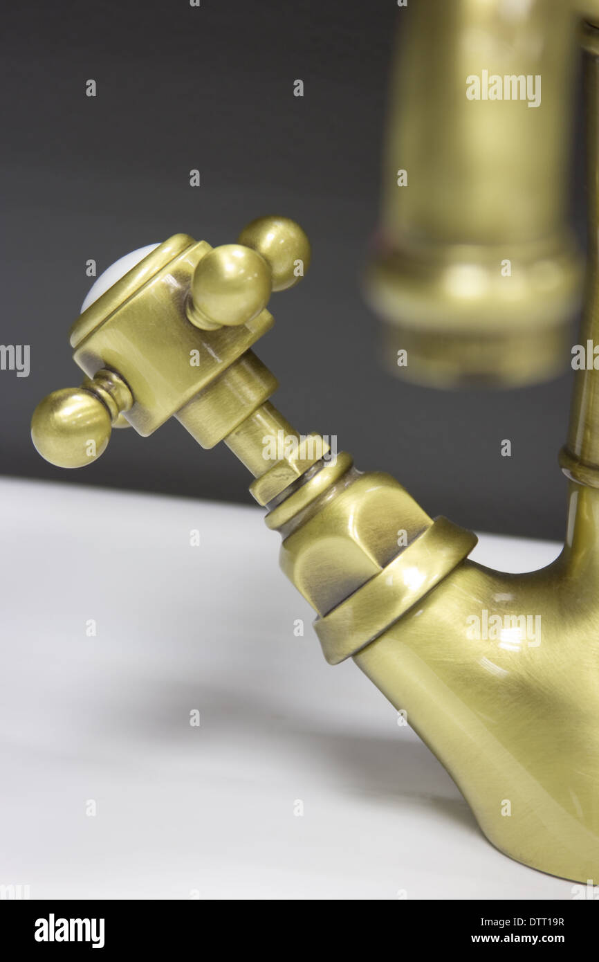 Retro-styled water bronze tap on sink Stock Photo - Alamy