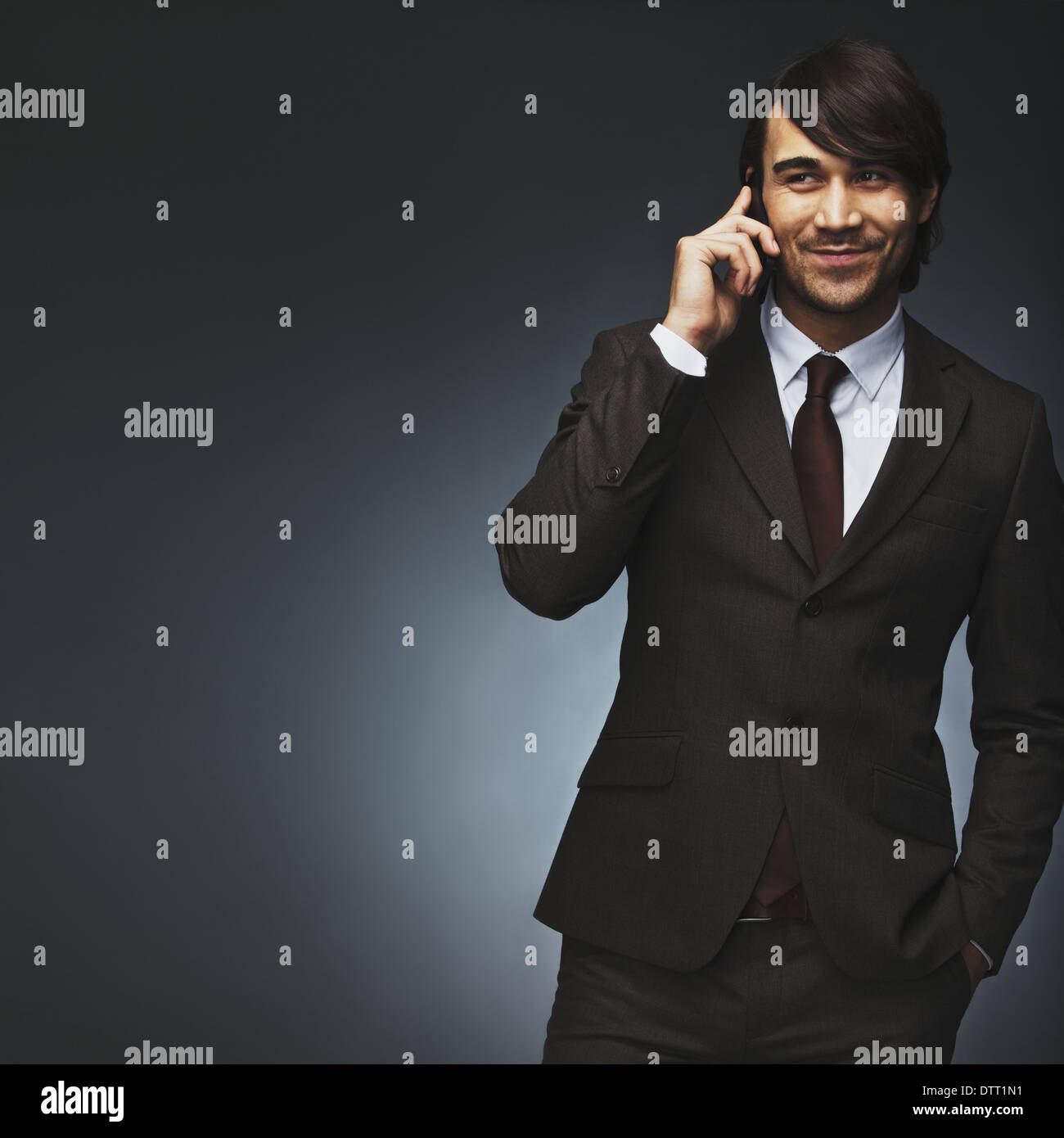 Asian man talking on mobile phone. Handsome young mixed race man on ... Asian man talking on mobile phone. Handsome young mixed race man on ...