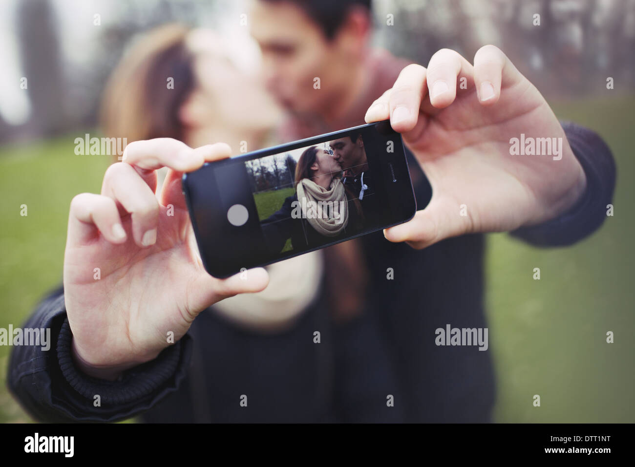 Loving young couple photographing themselves with a mobile phone while ...