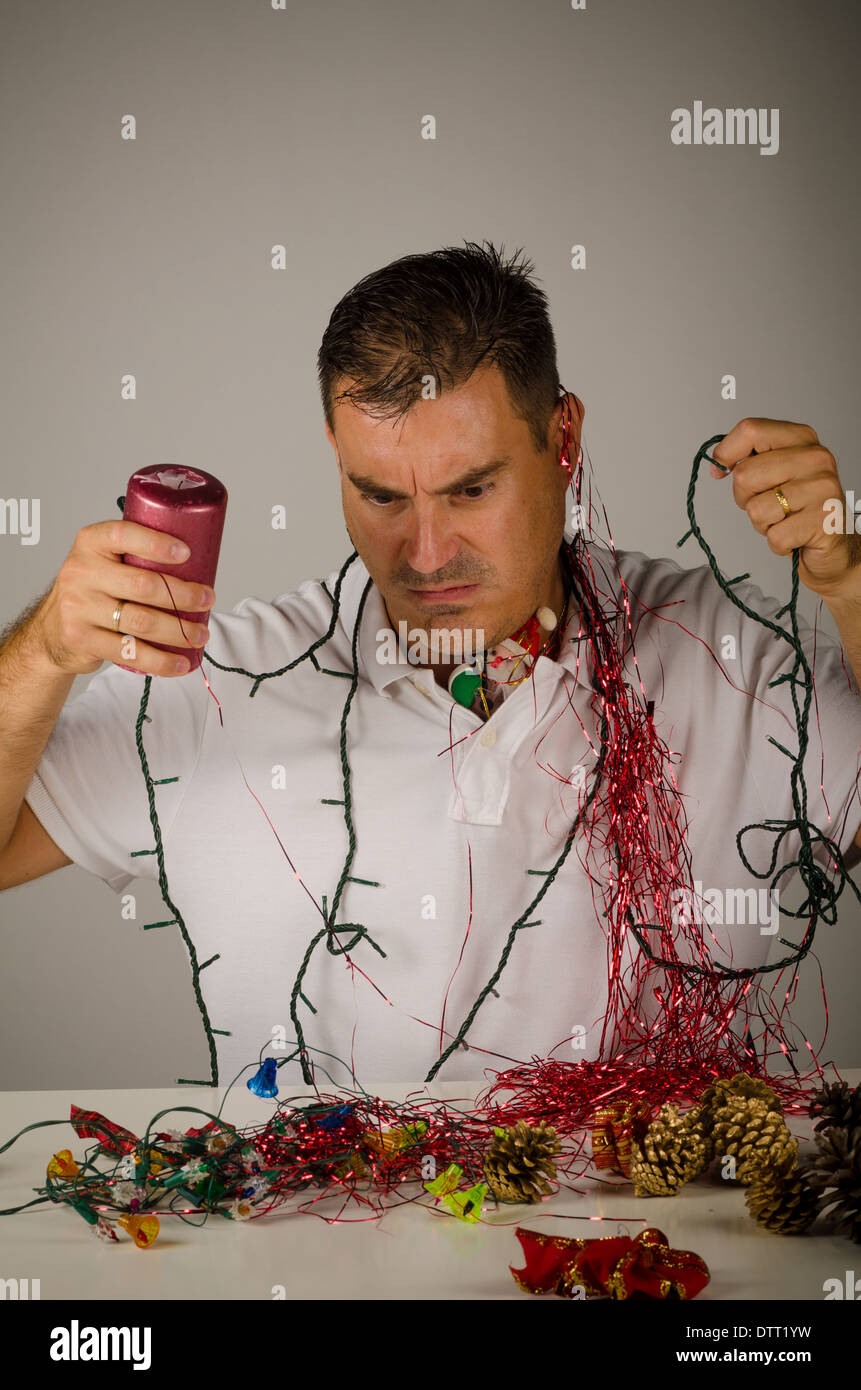 Guy tangled in between a mess of party decoration Stock Photo - Alamy