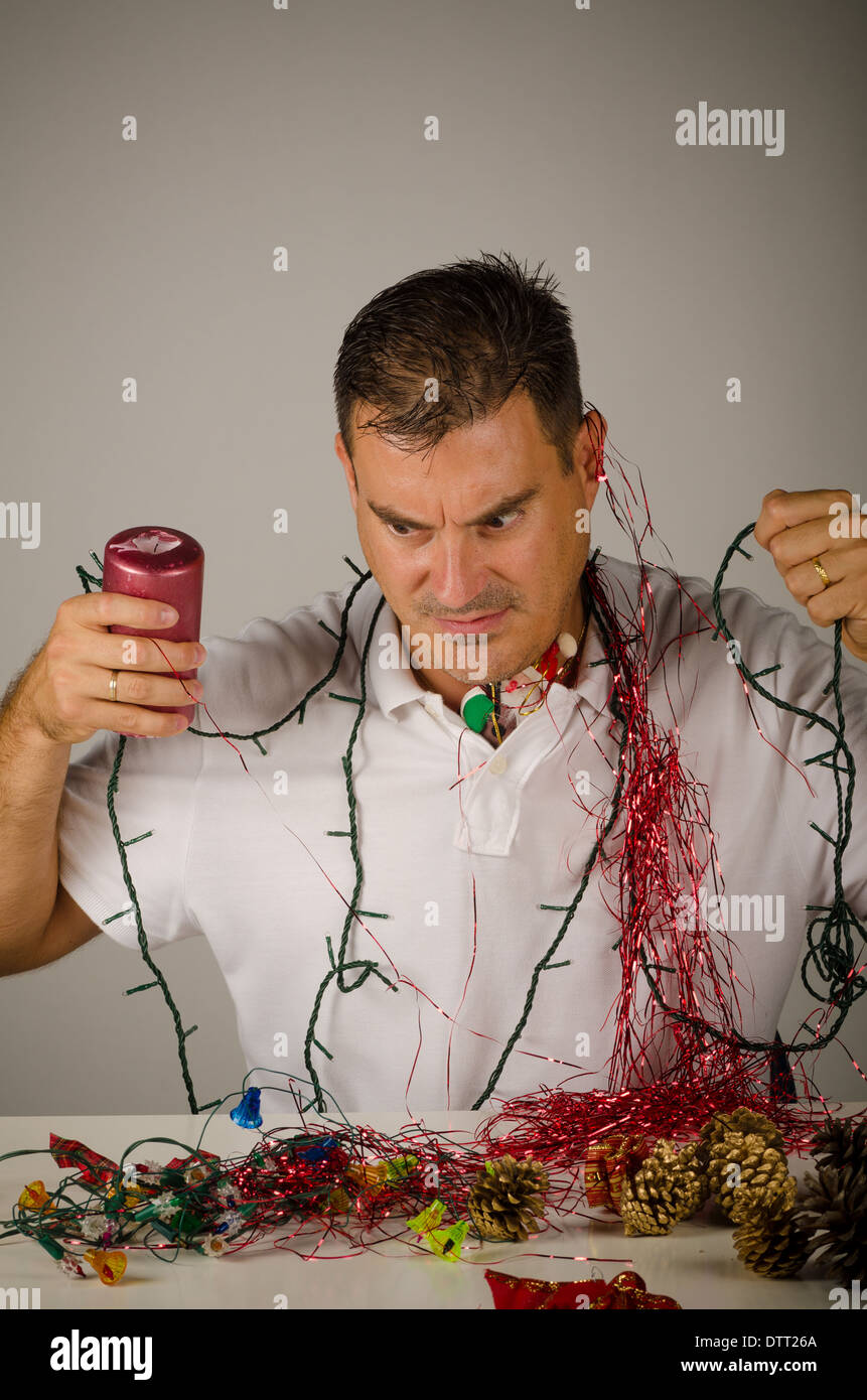 Guy tangled in between a mess of party decoration Stock Photo - Alamy