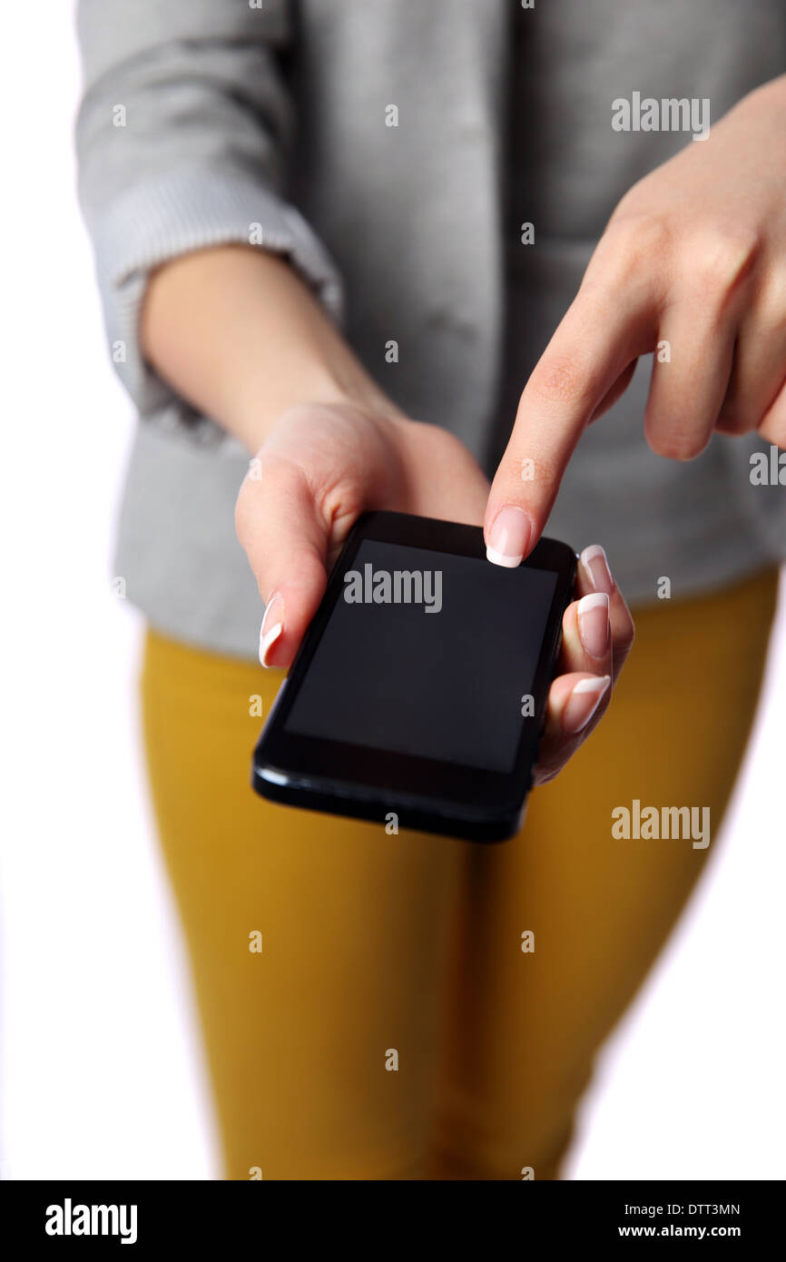 Woman pointing at smartphone screen isolated on a white background ...