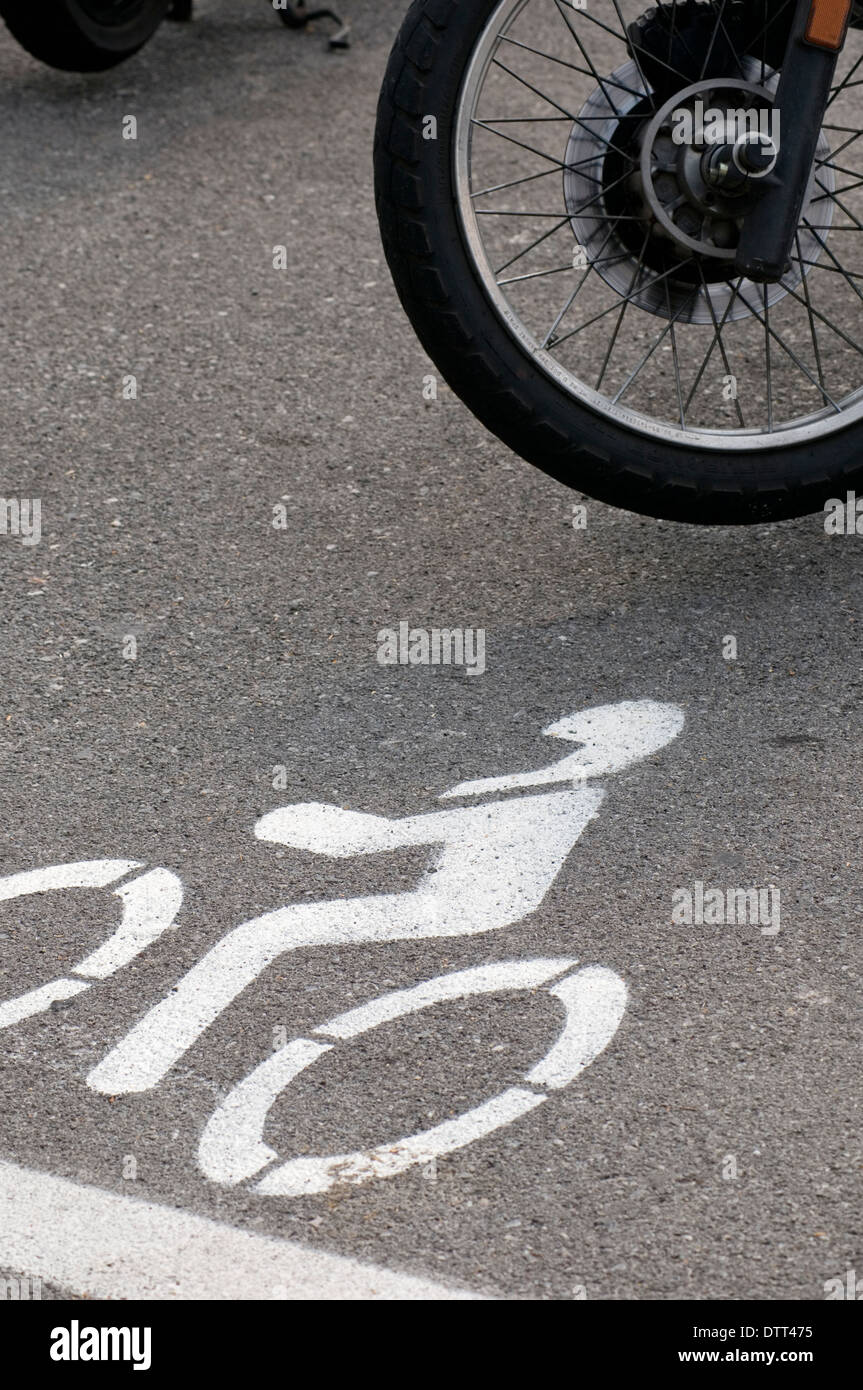 Motorbike wheel and parking sign on tarmac Stock Photo - Alamy