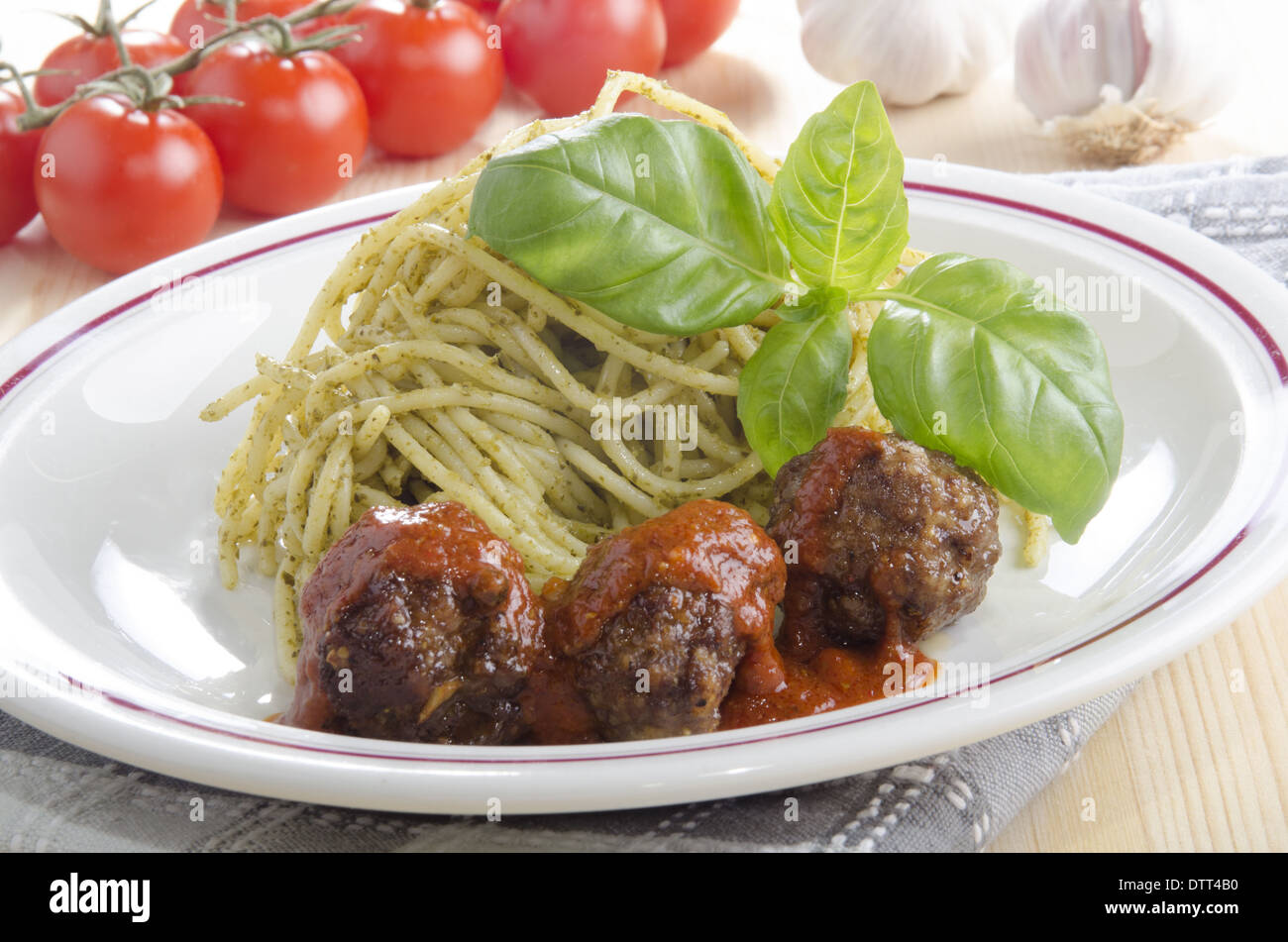 spaghetti with pesto and italian meat balls on a plate Stock Photo - Alamy
