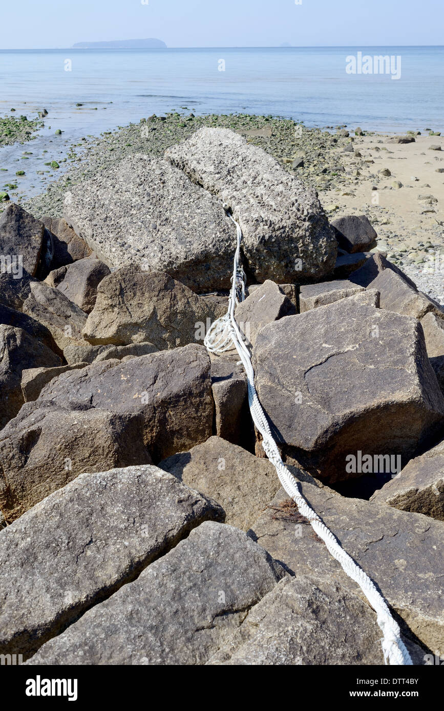 ship cable caught in the rock on seacoast Stock Photo - Alamy