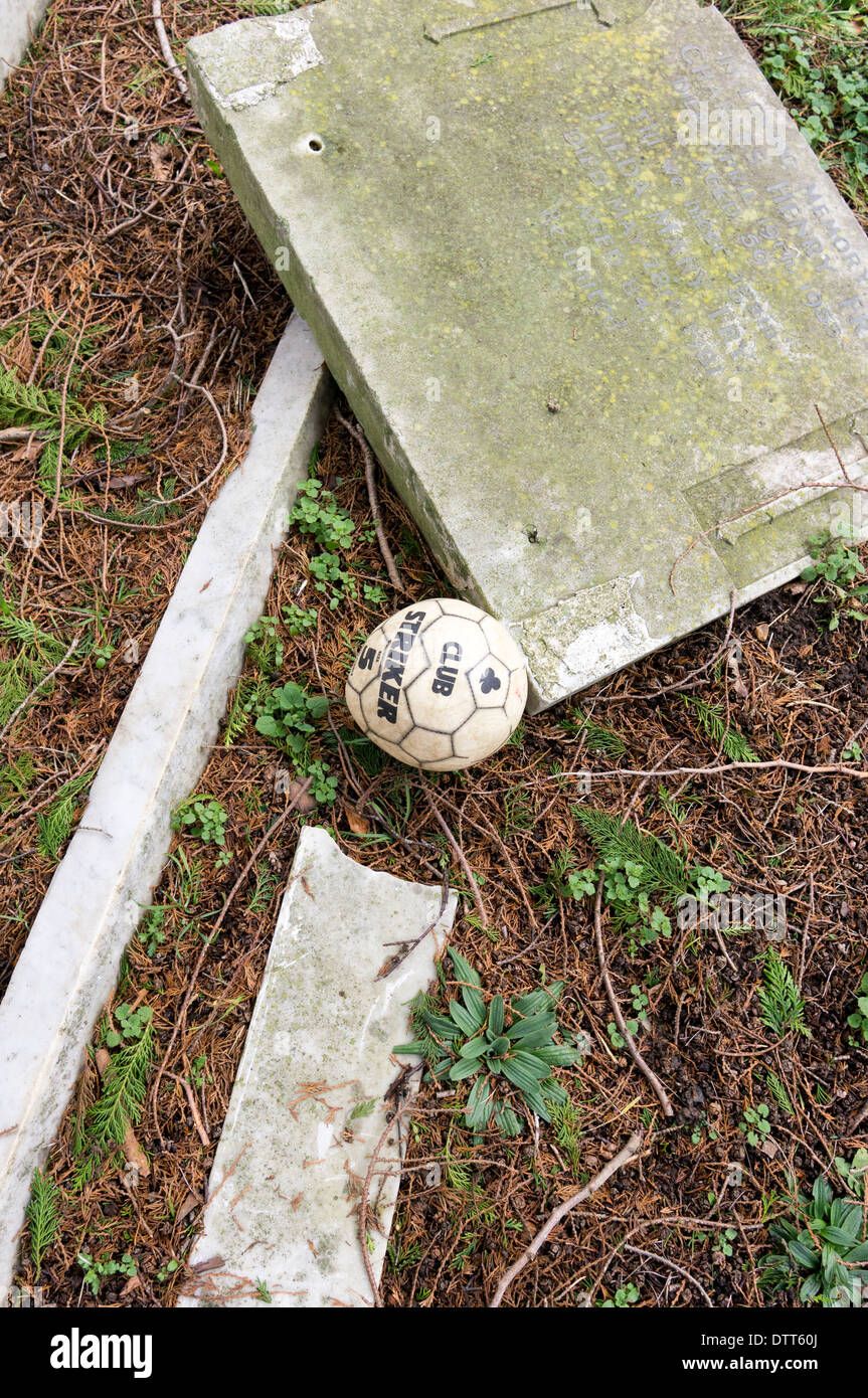 Deflated and punctured football on waste land Stock Photo - Alamy