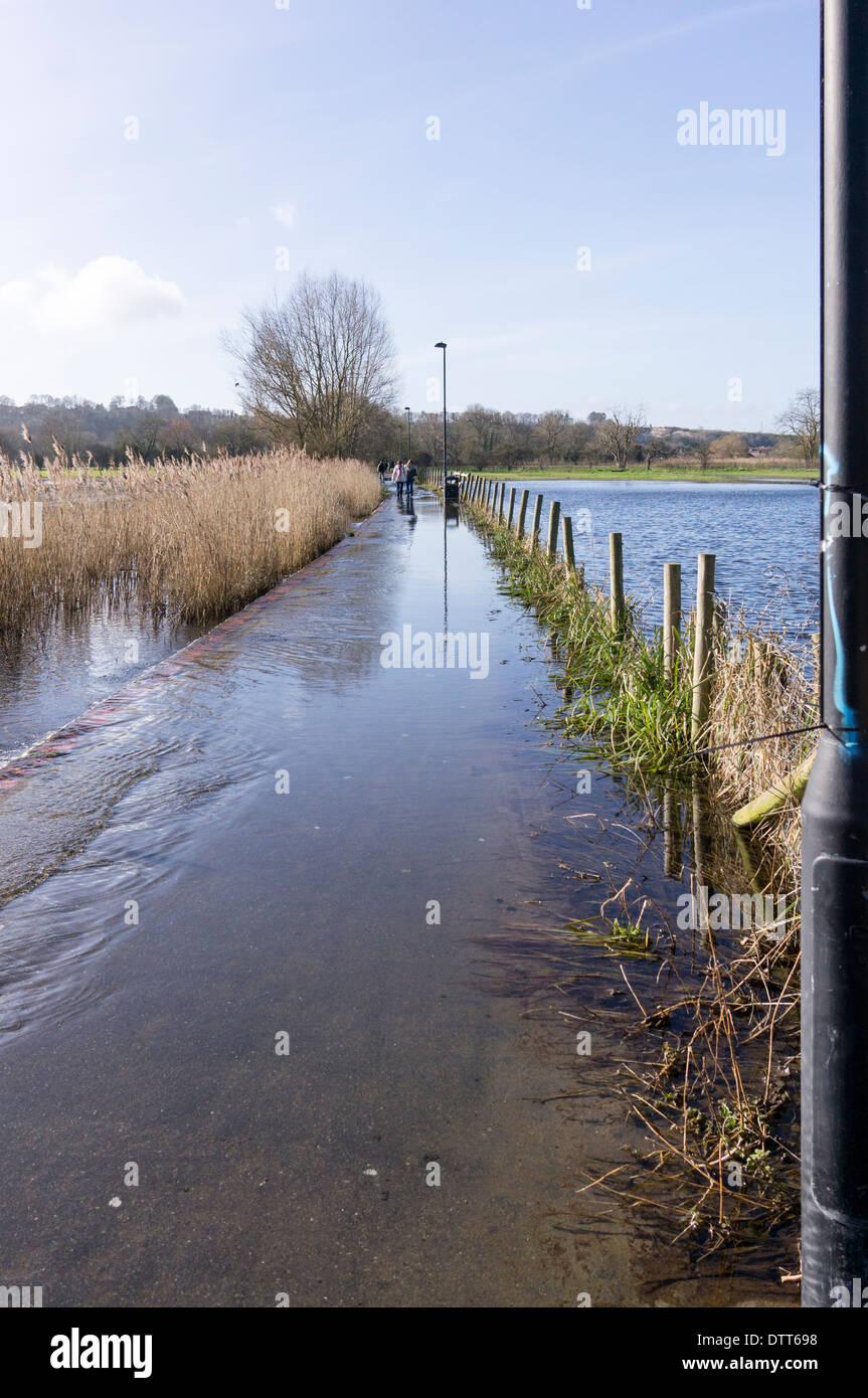 Water running over flooded footpath during high rainfall and flooding ...