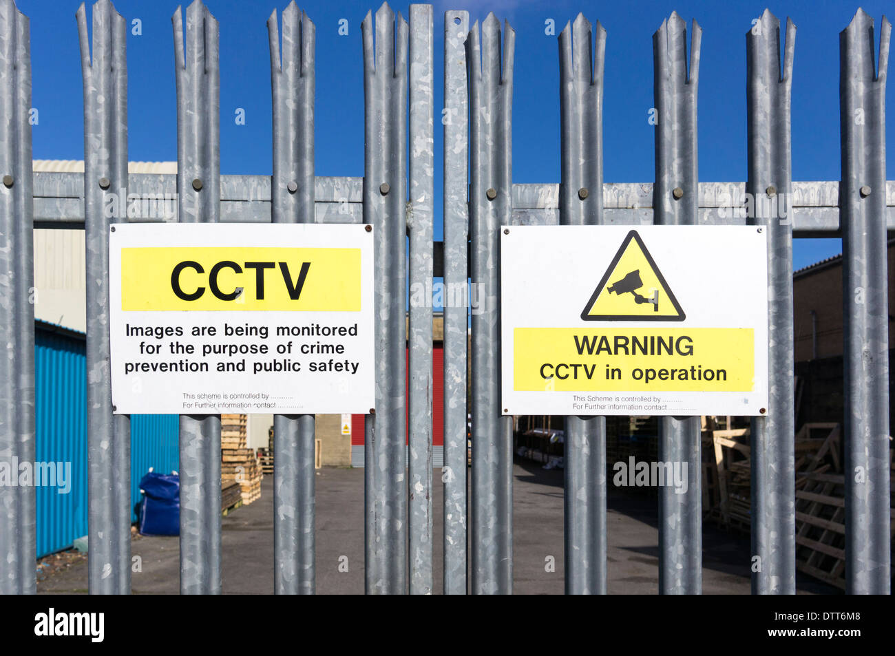 CCTV warning sign on metal gate Stock Photo - Alamy
