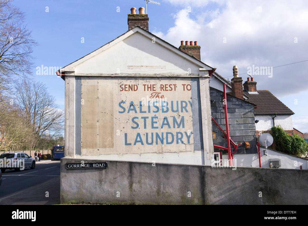 Old fashioned hand painted advertising sign on the side of a UK house ...