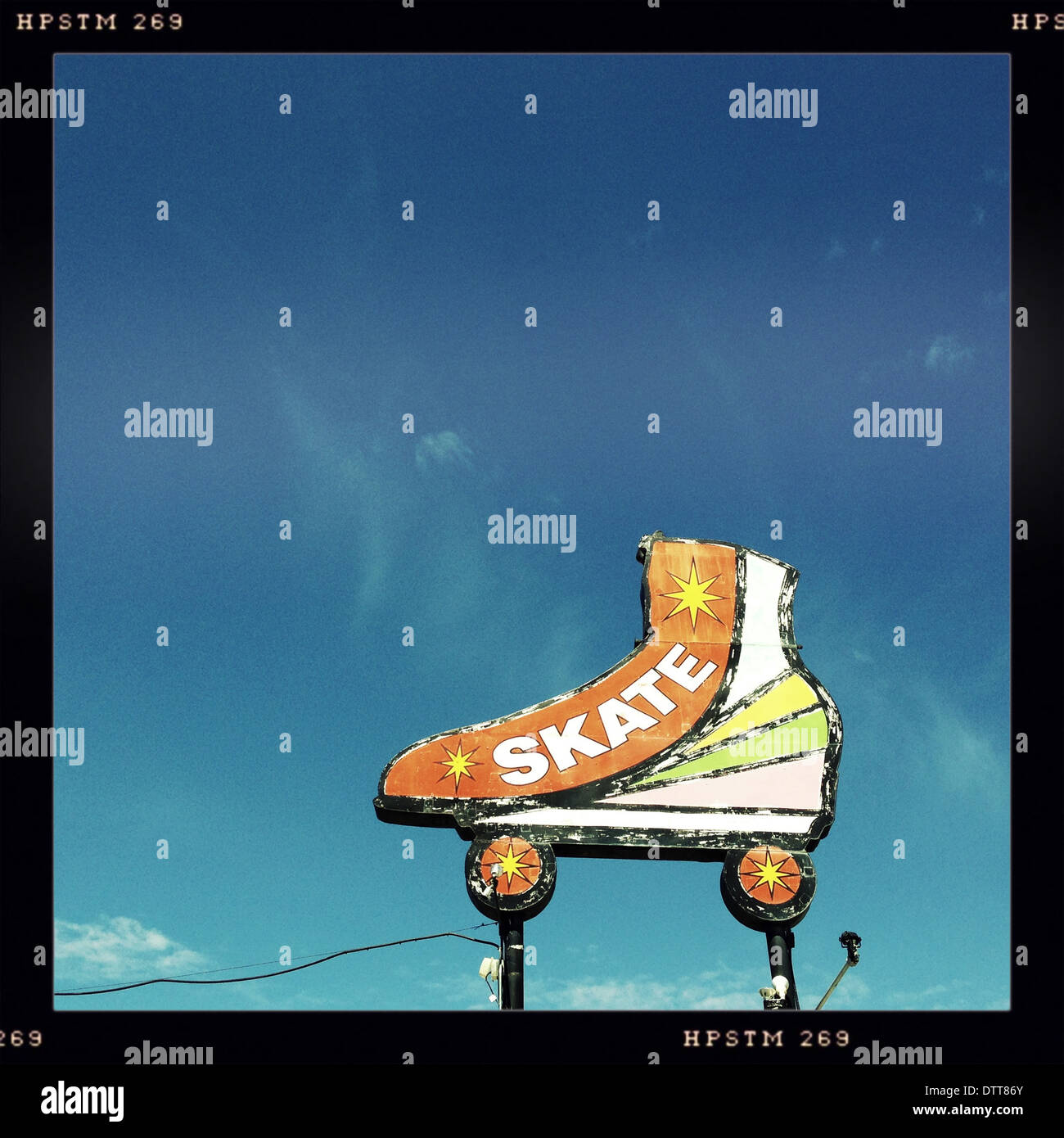 Neon roller skate sign in blue sky Stock Photo - Alamy