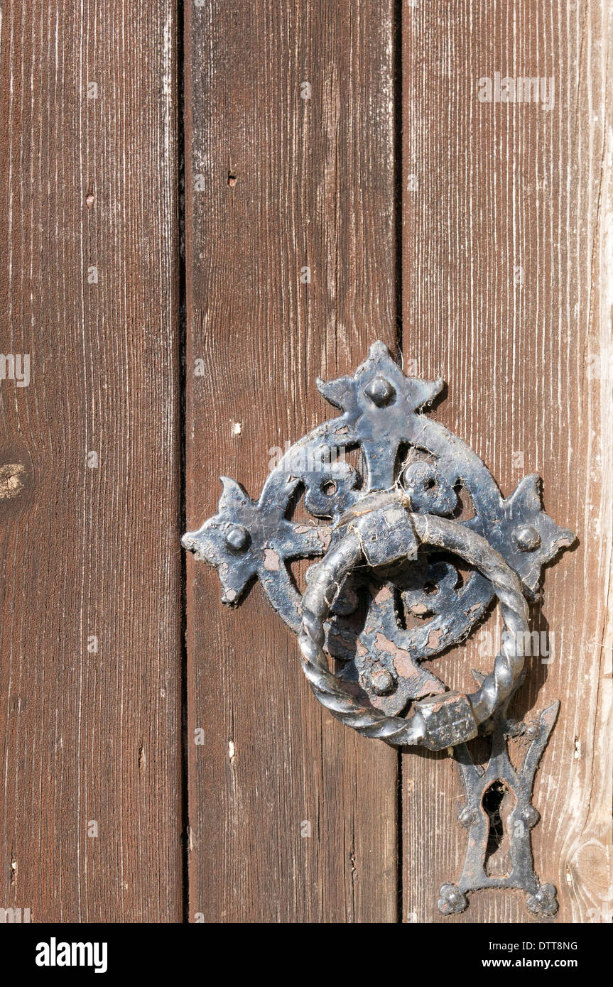 Old decorative circular wrought iron door latch handle and key hole on ...