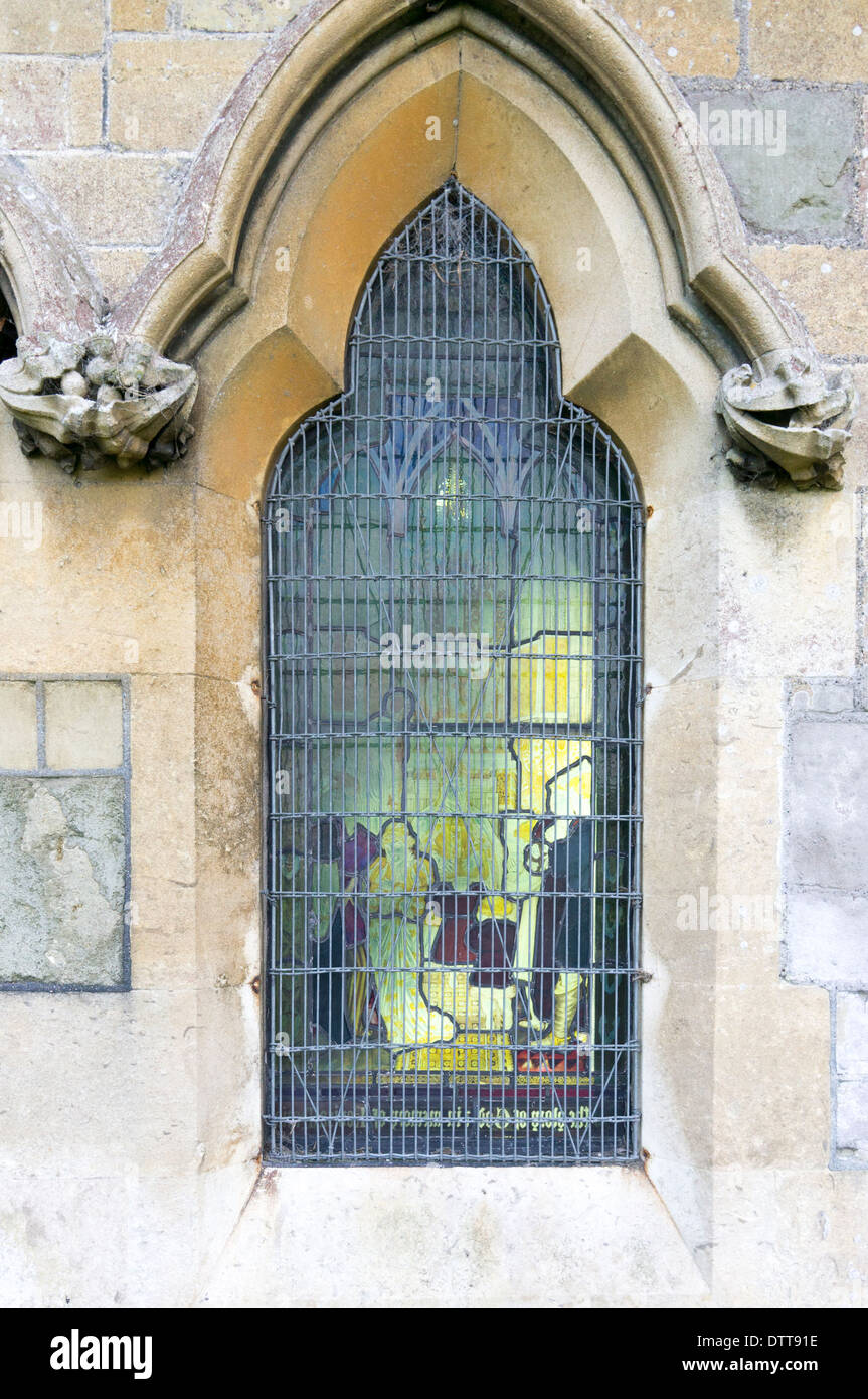 Protective wire grill over stained glass window in UK church Stock ...