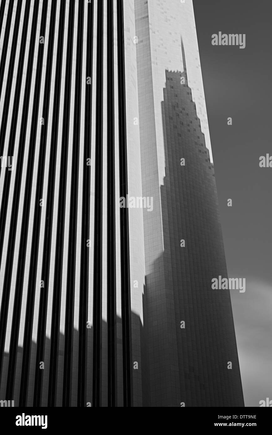 Skyscraper casting shadow on office building Stock Photo - Alamy